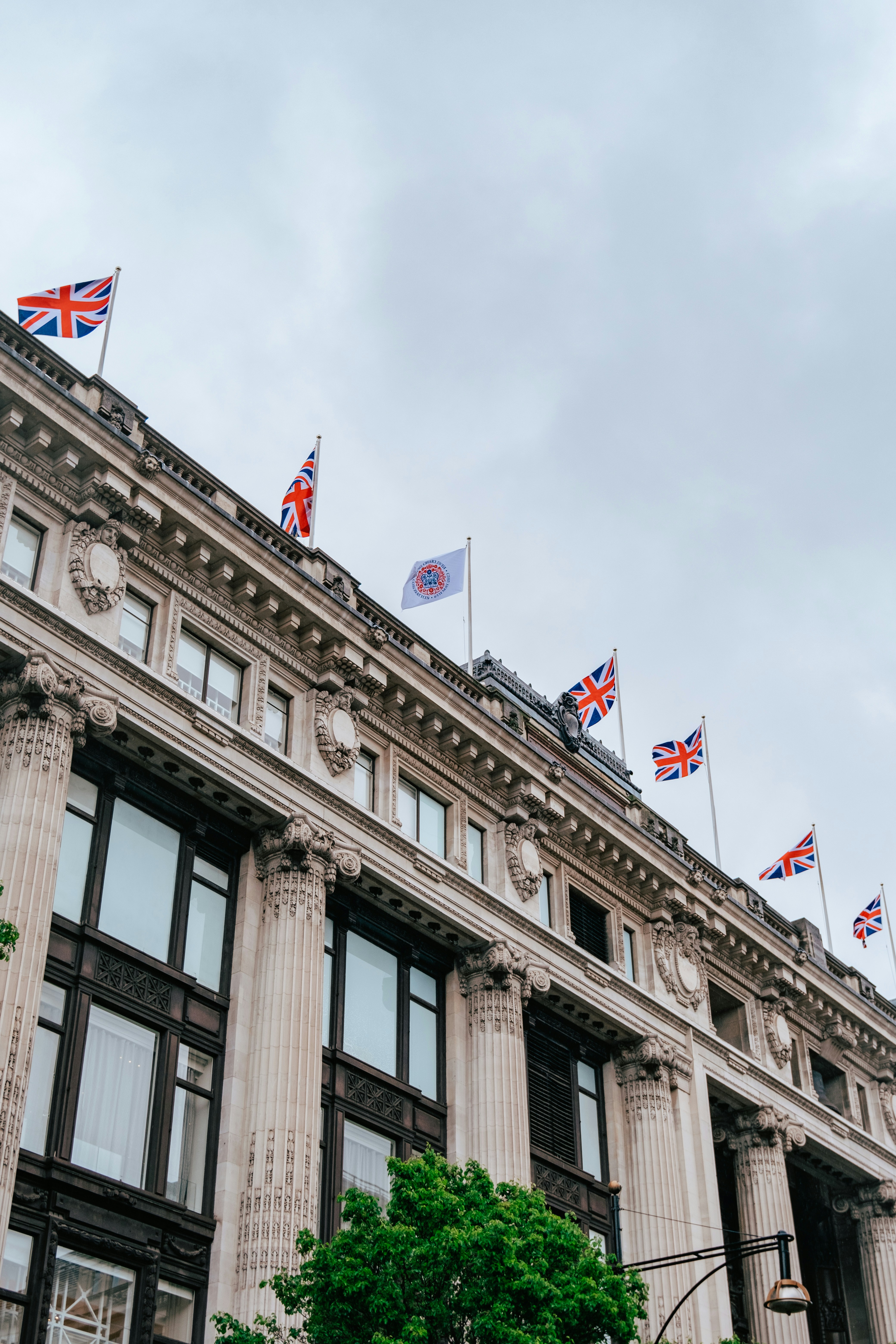 A tall building with flags on top of it photo – Free Hyde park Image on ...