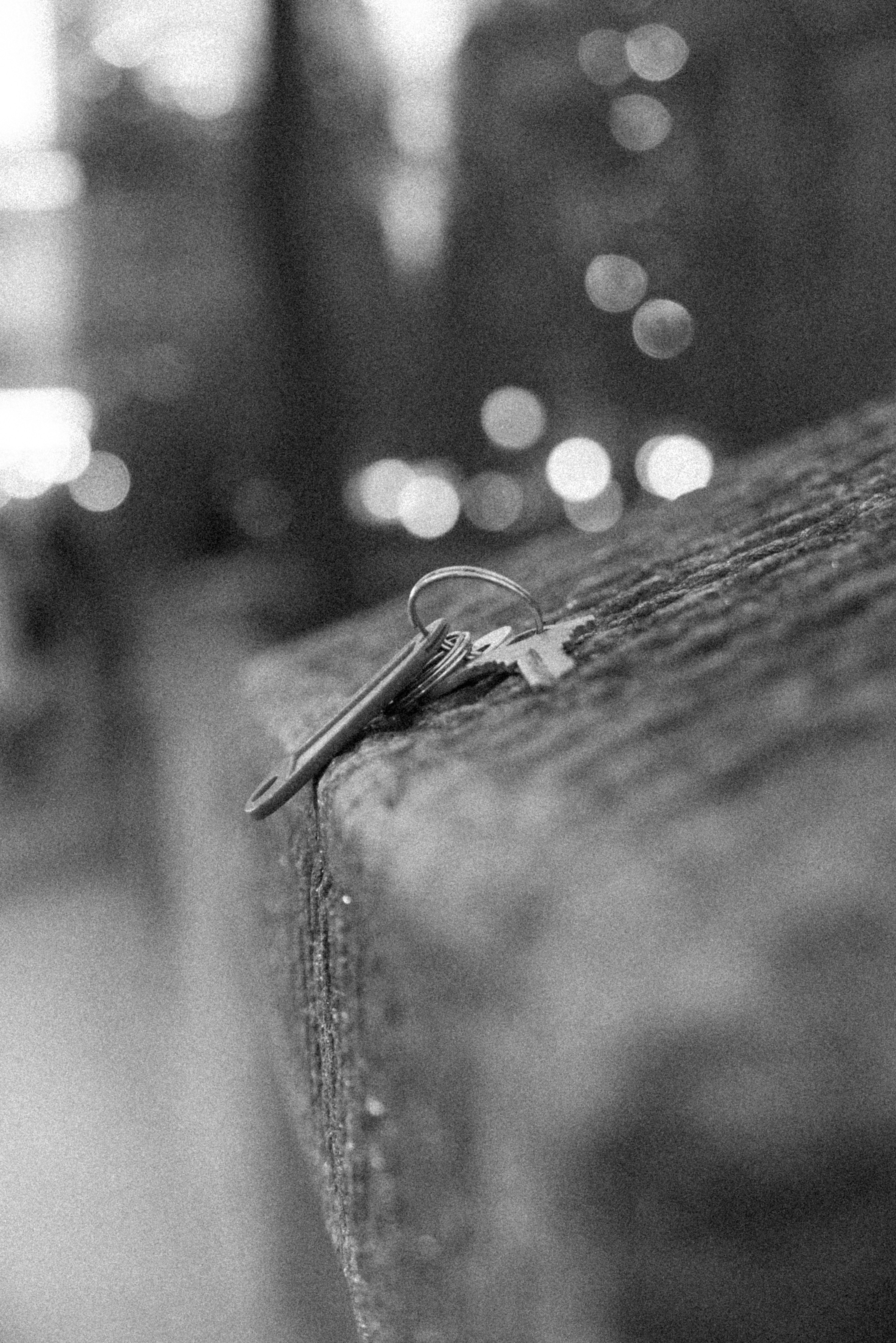 Tiny Key on Weathered Plank, City Lights Blooming in the Blur
