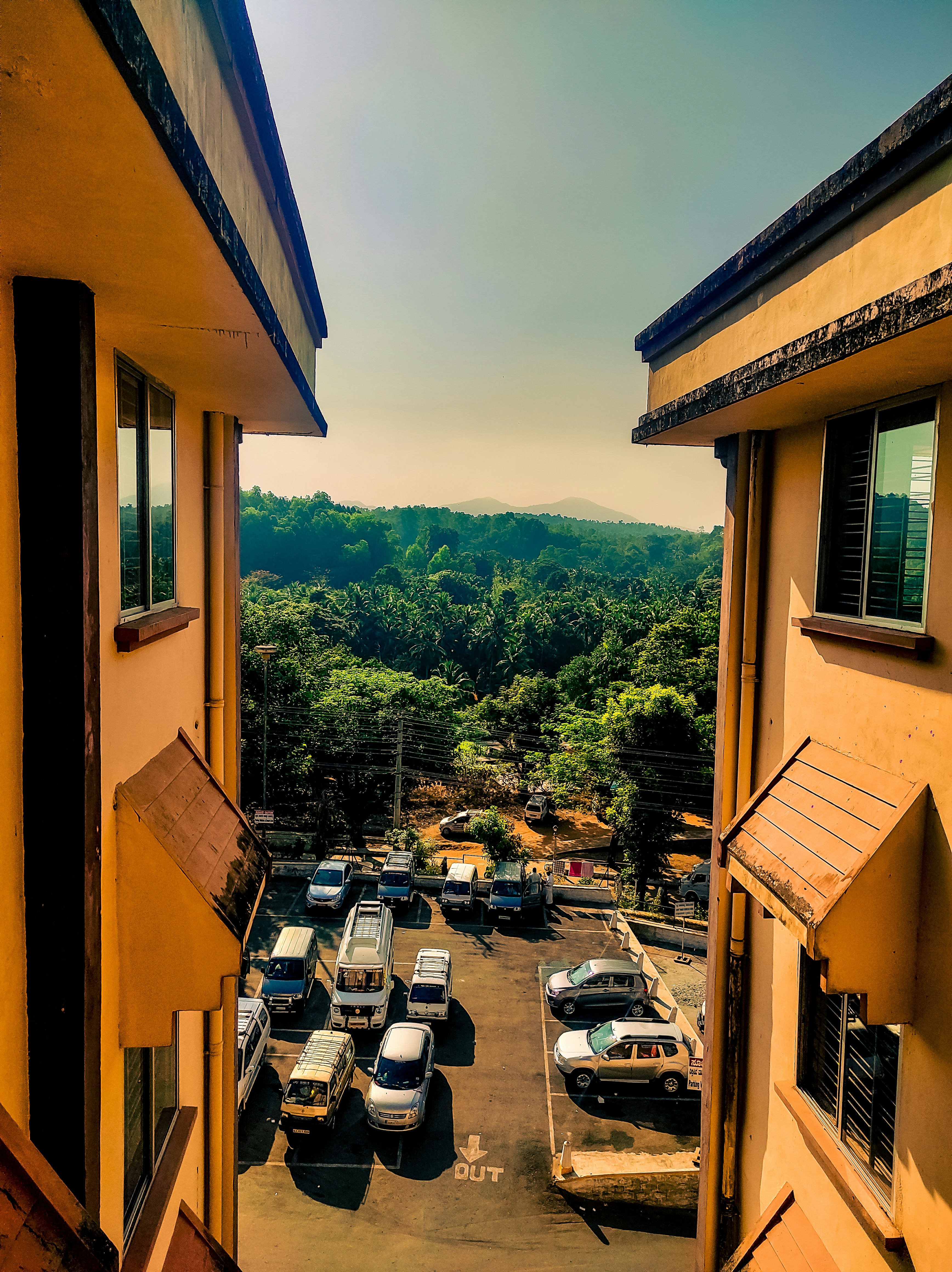 Framed Between Tangerine Wings: Parking Lot Echoes of Distant Hills