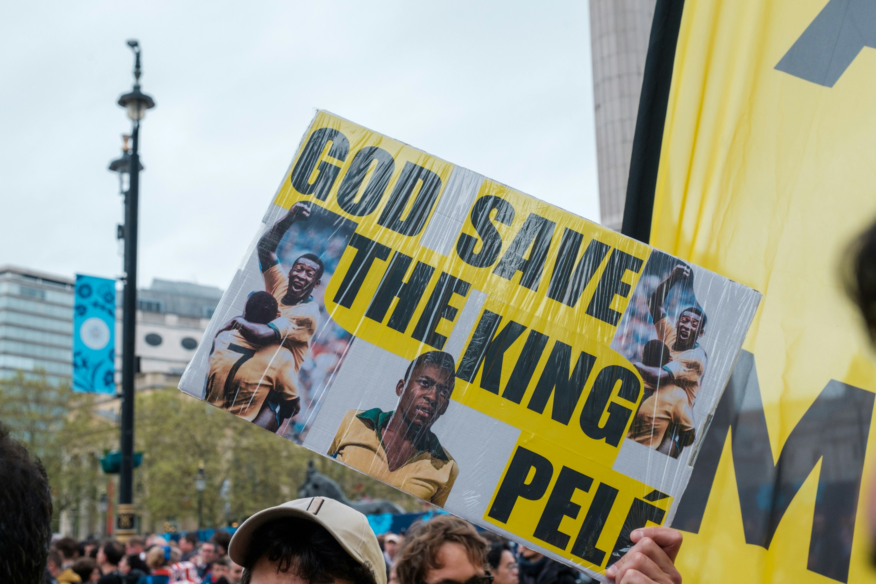 A man holding a sign that says god shine the king pell photo – Free ...