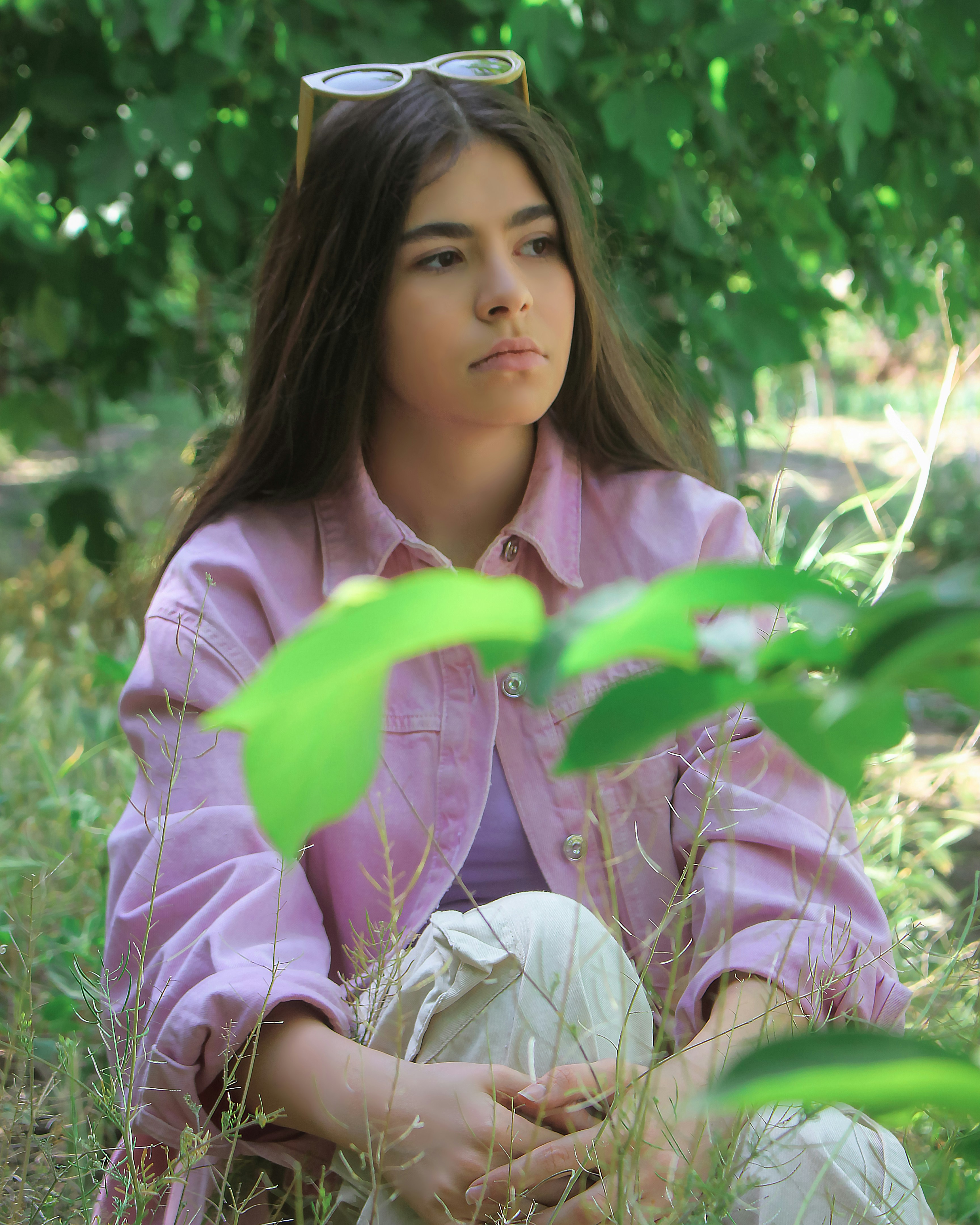 Pink Jacket, Quiet Focus: Portrait Amid Gentle Greenery
