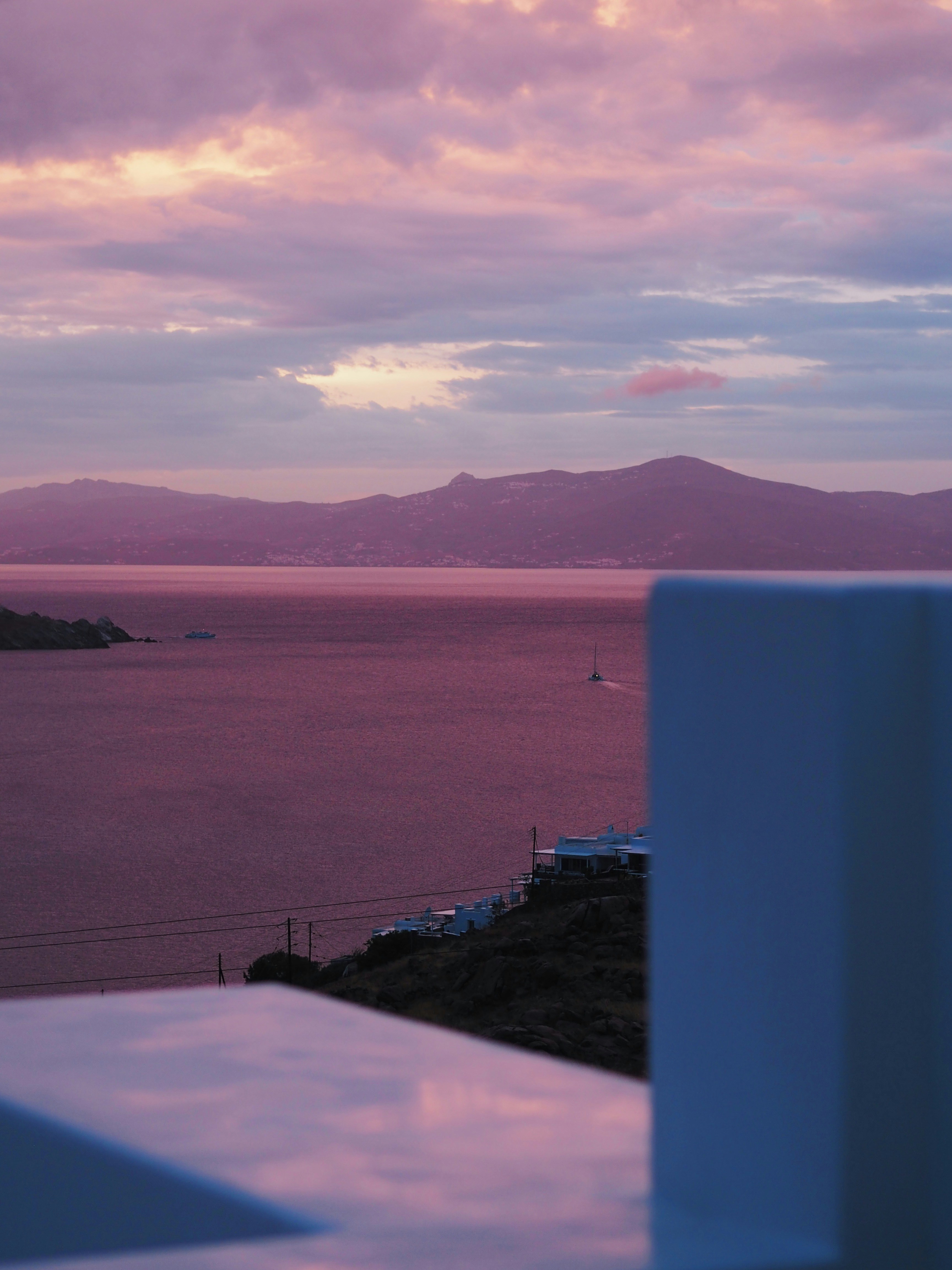 Lavender Horizon: A Quiet Boat Drifts Under Pastel Sunset
