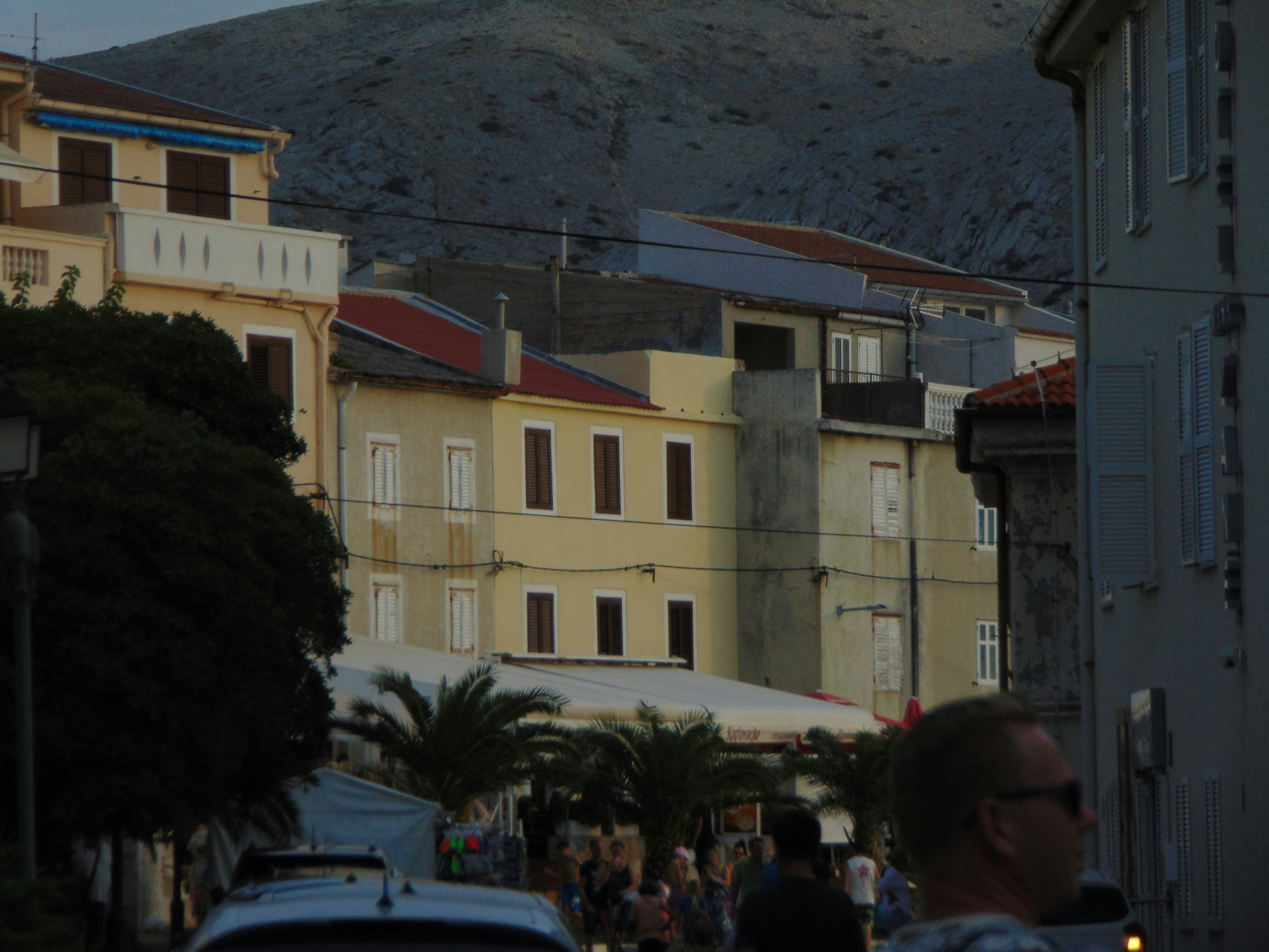 Pastel Facades and Palm Market Under Mountain Light