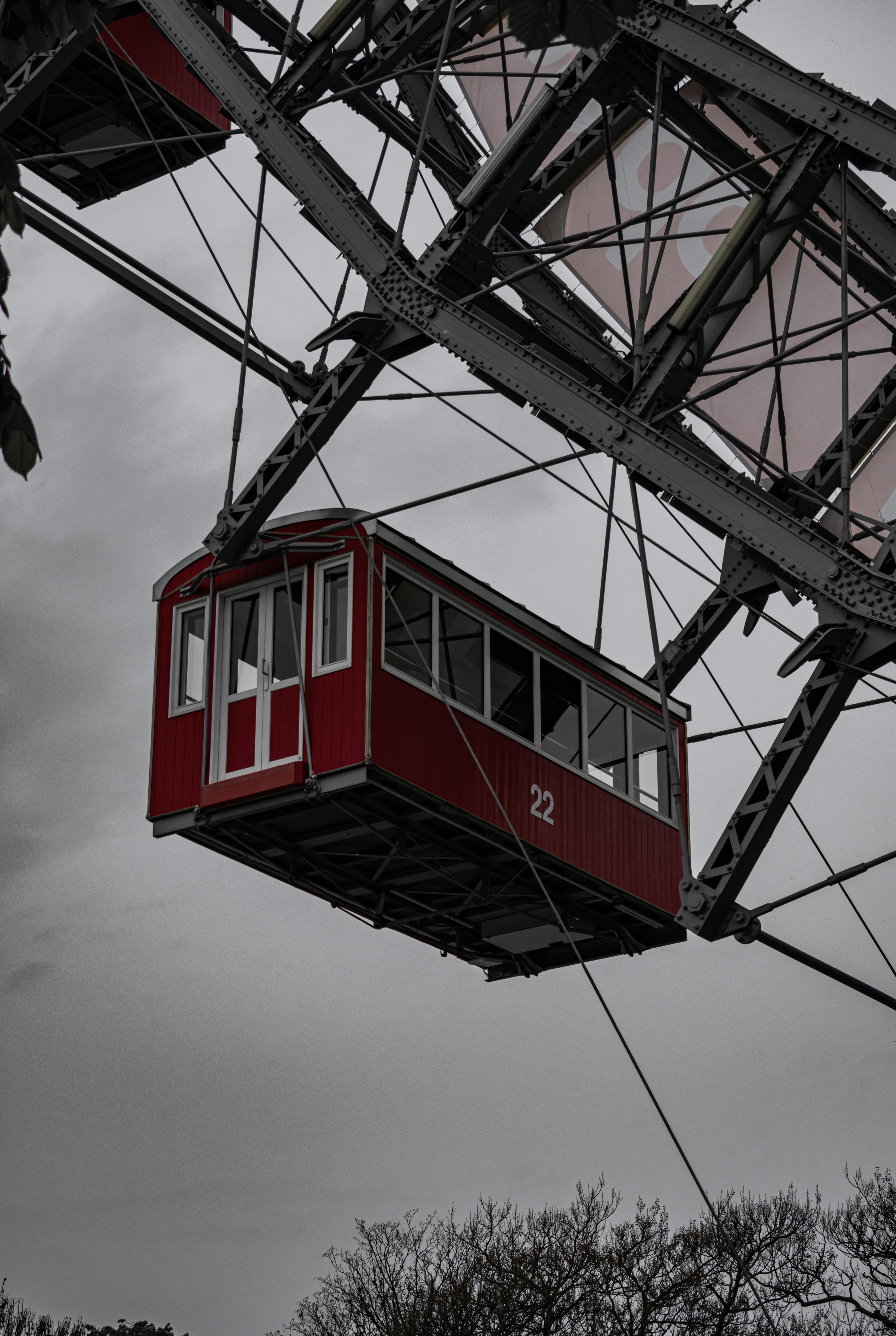 A red cable car suspended from the side of a building photo – Free ...