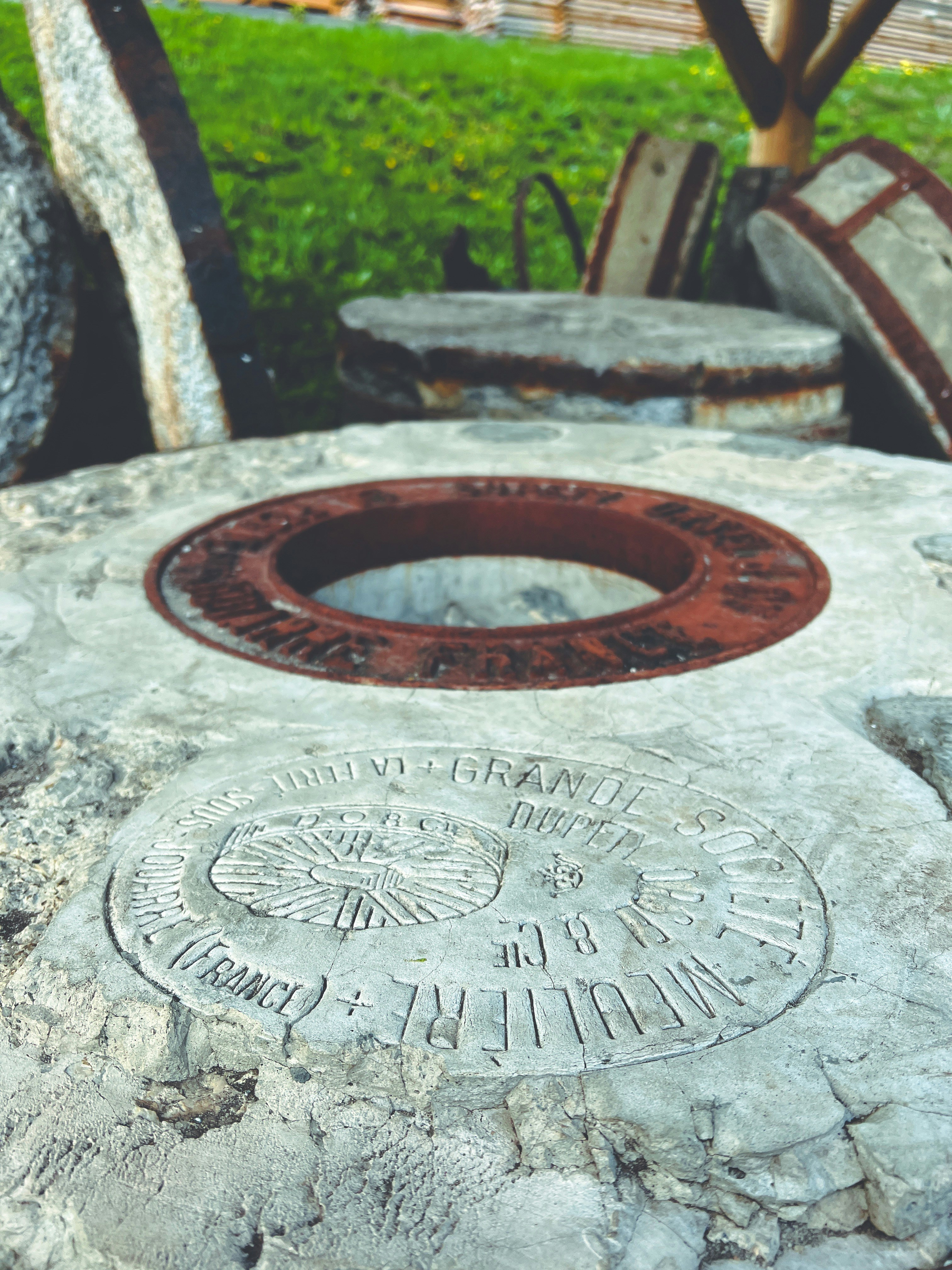 Circular Emblems on Weathered Granite: A Parkside Close-Up