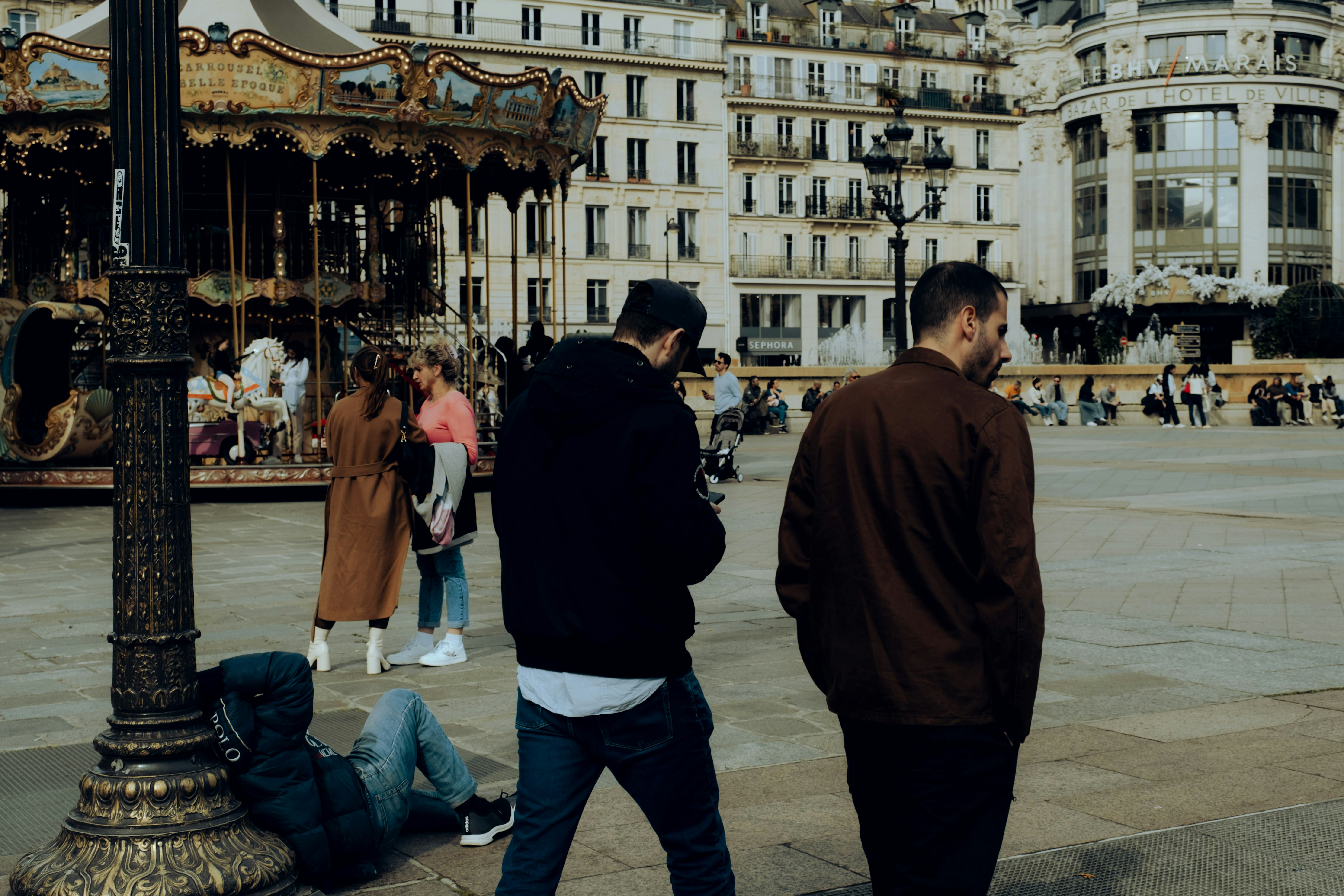 Backs to the City: A Quiet Moment in a Bustling Square