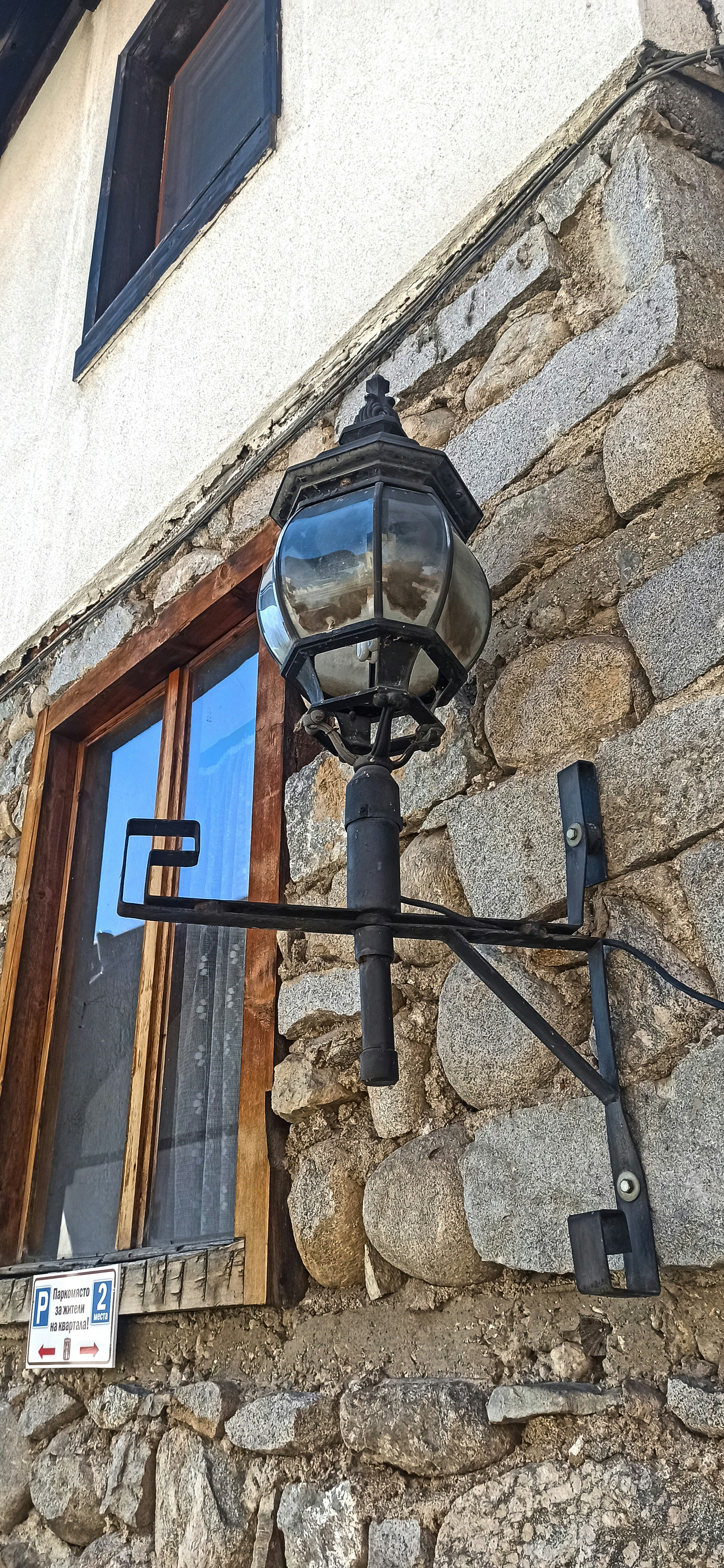 A light on the side of a stone building photo – Free Bansko Image on ...