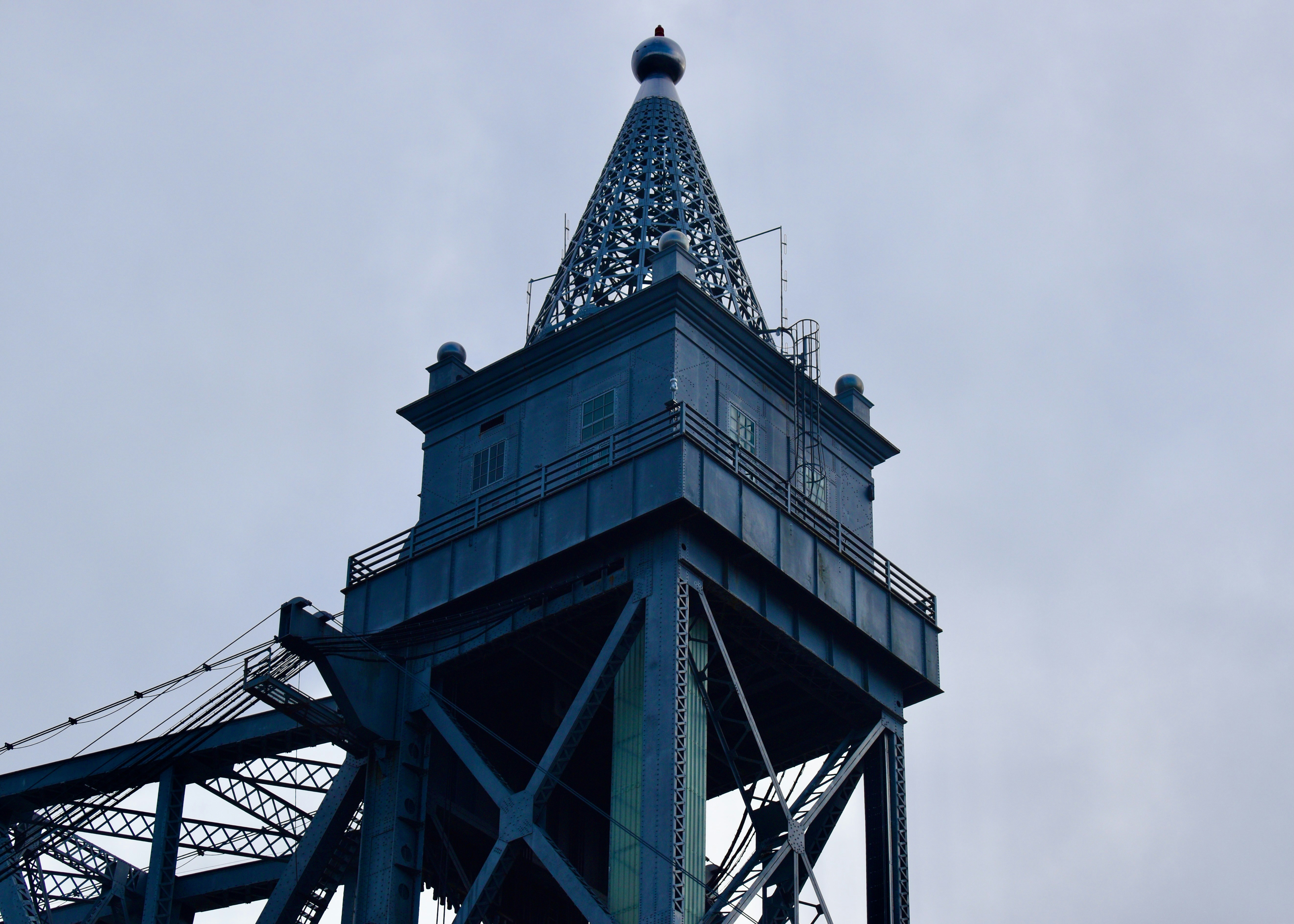 Azure Lattice Crown: A Bridge Tower Reaches Toward a Quiet Sky