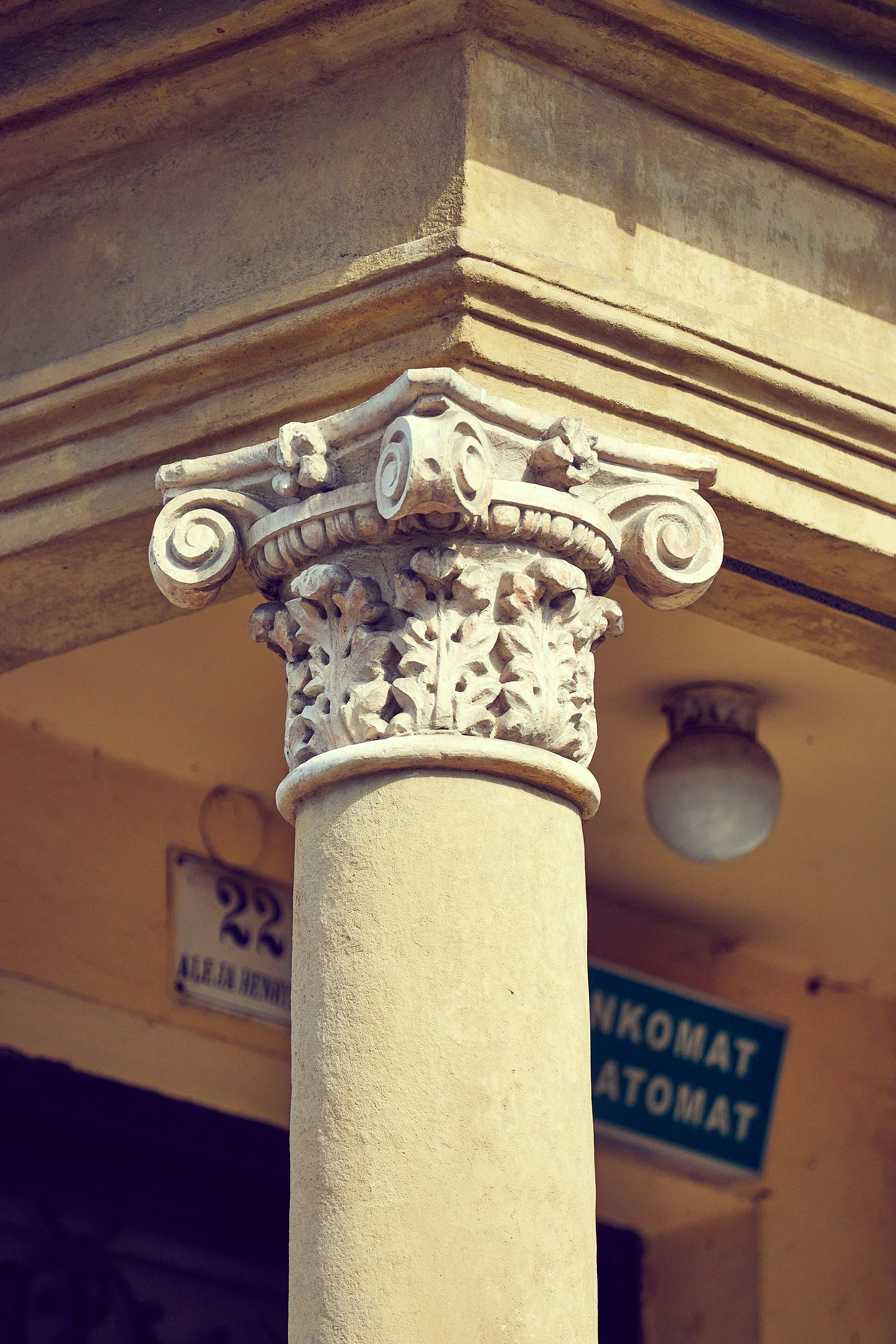 Carved Corinthian Capital Under Warm Light