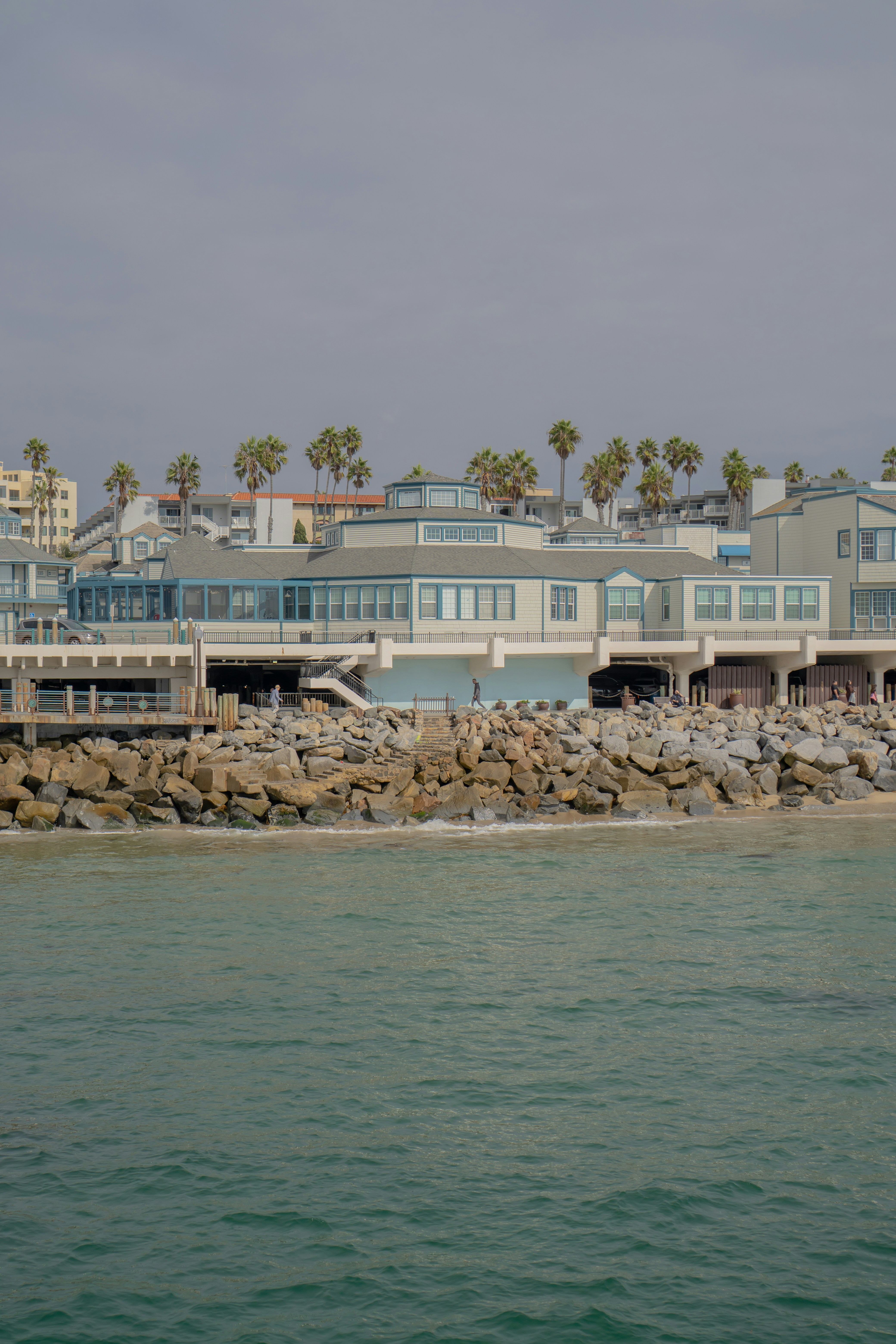 Seaside Boardwalk Buildings Rise Above Calm Atlantic Waters