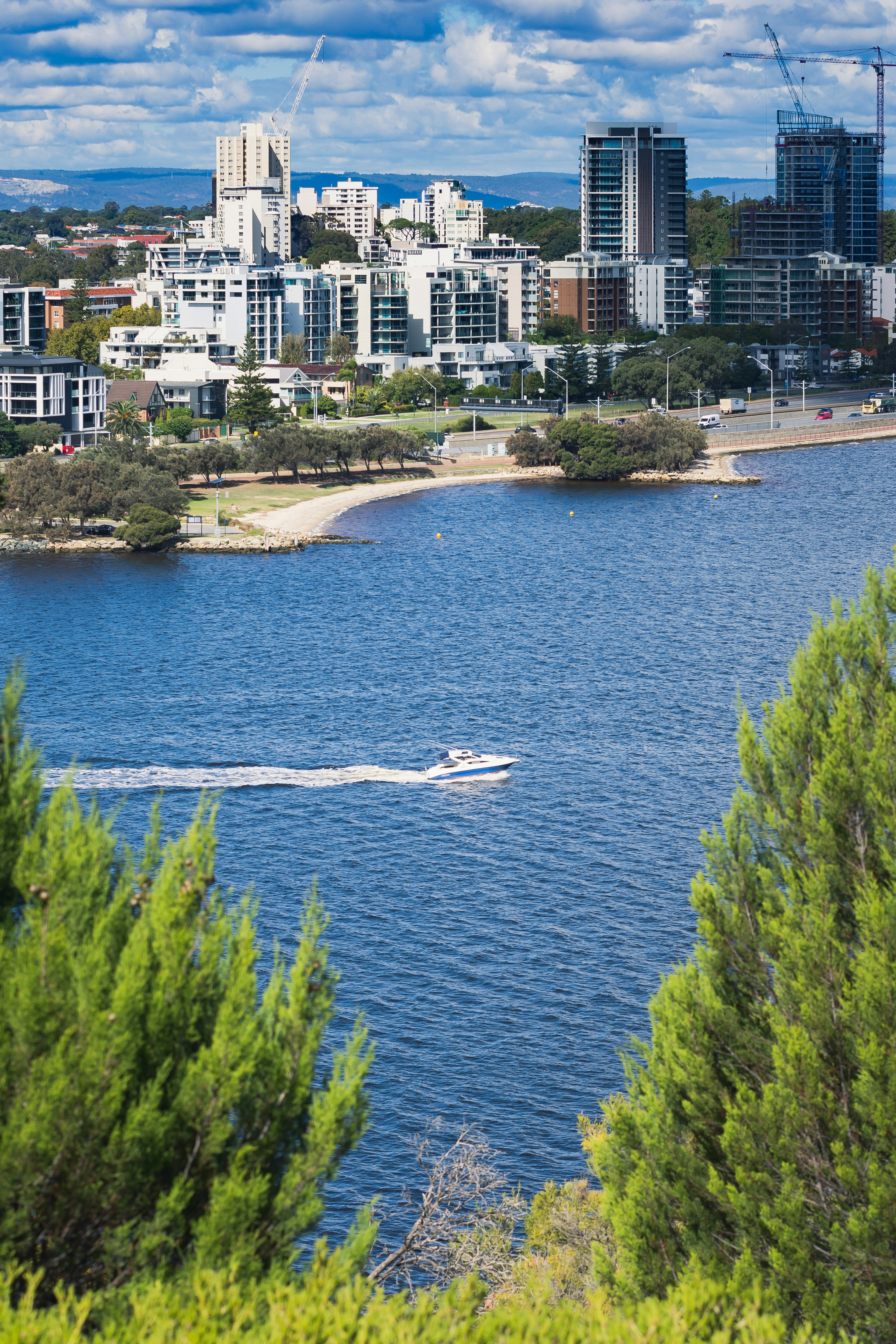 City by the Bay: A Speedboat Rips Across a Quiet Waterfront
