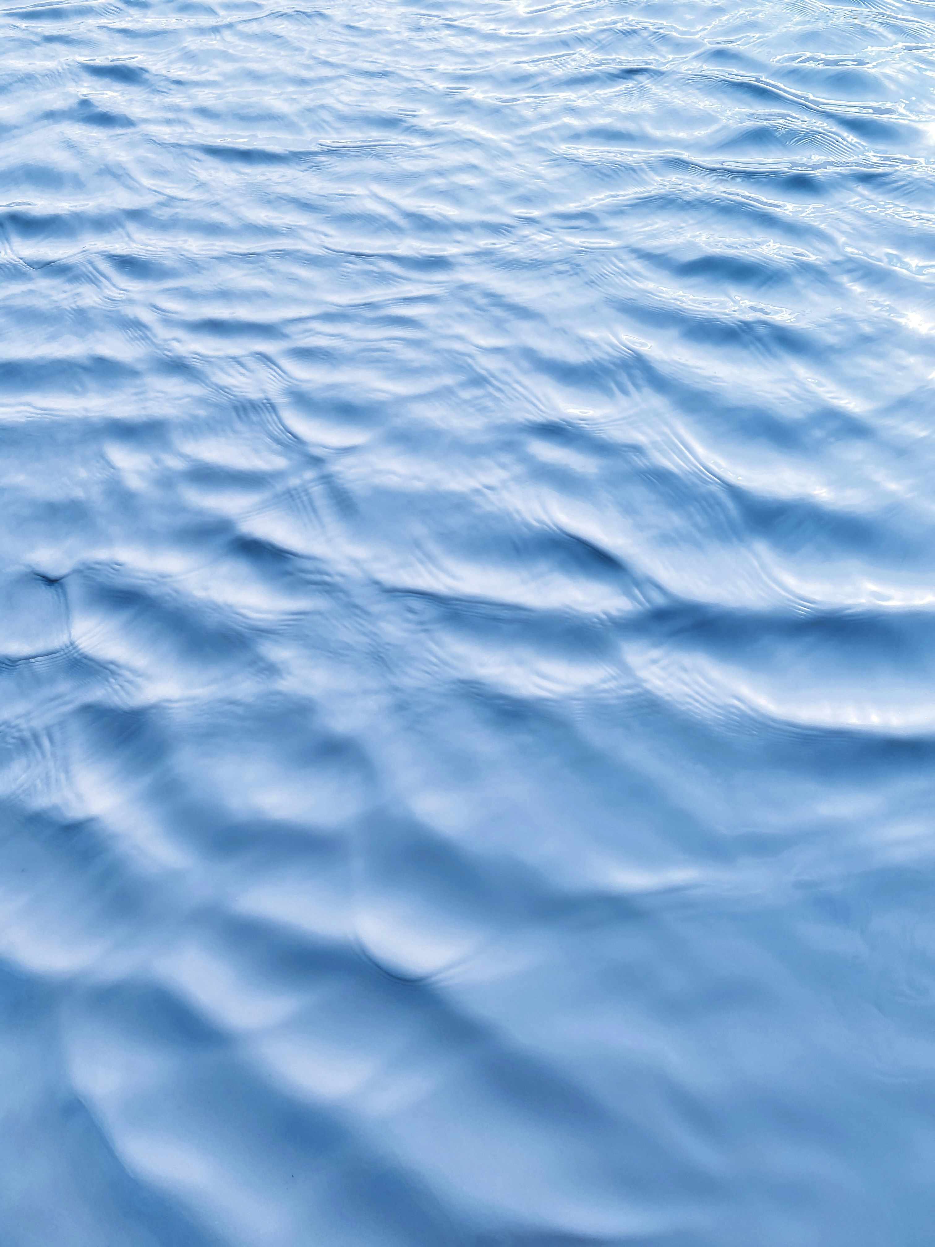 A large body of water with ripples on it photo – Free Nature Image on ...