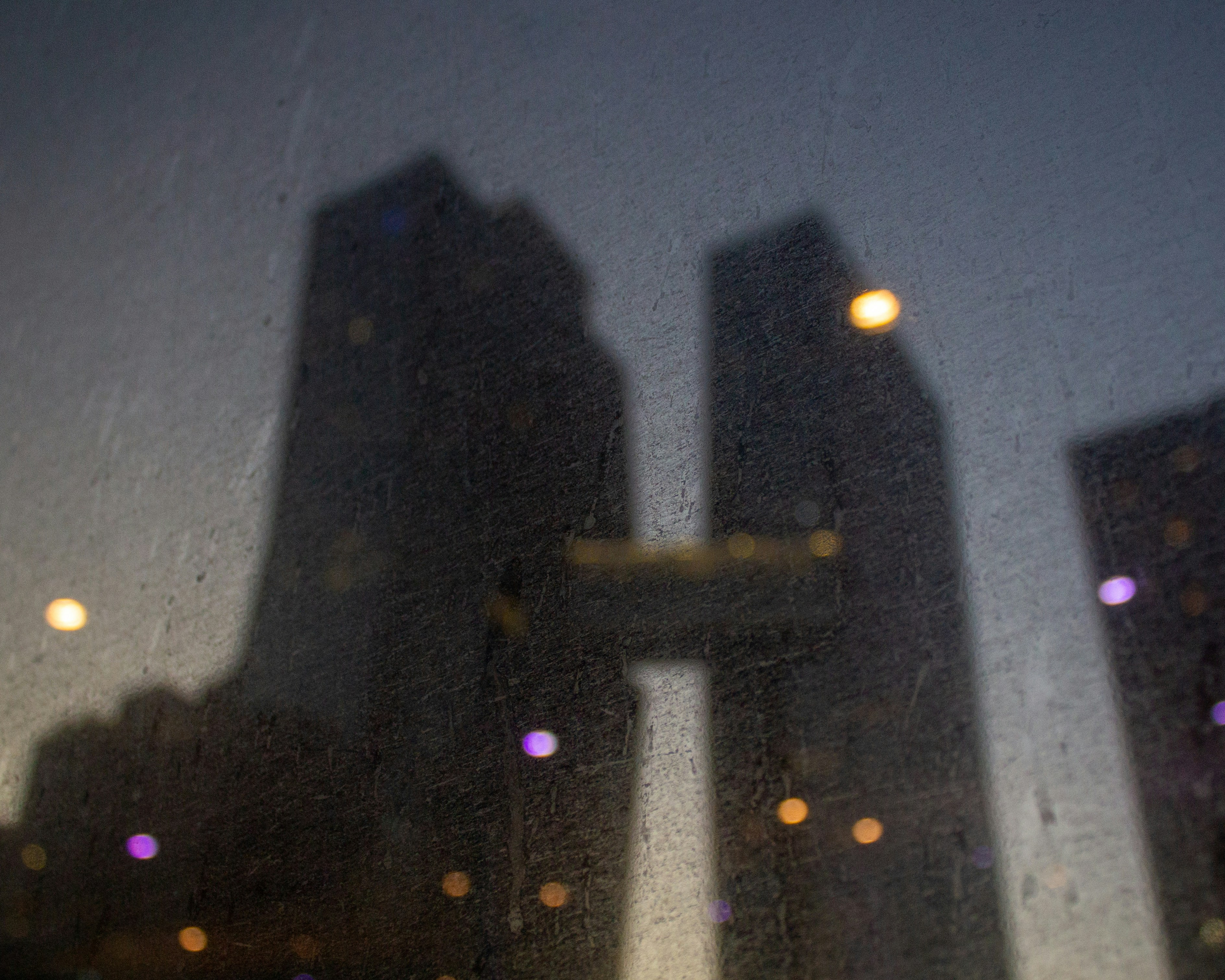 A blurry picture of a city skyline with buildings in the background ...