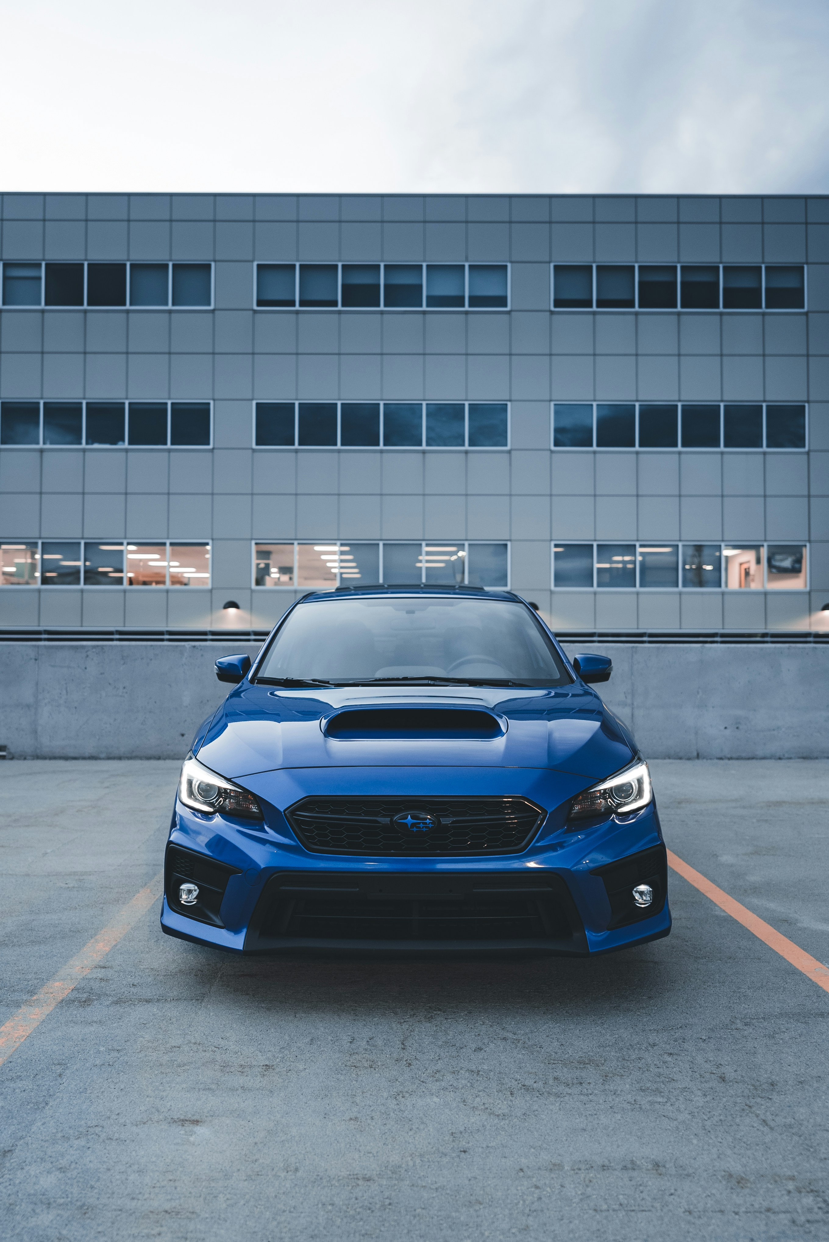 A blue subaru is parked in a parking lot photo – Free Bumper Image on ...