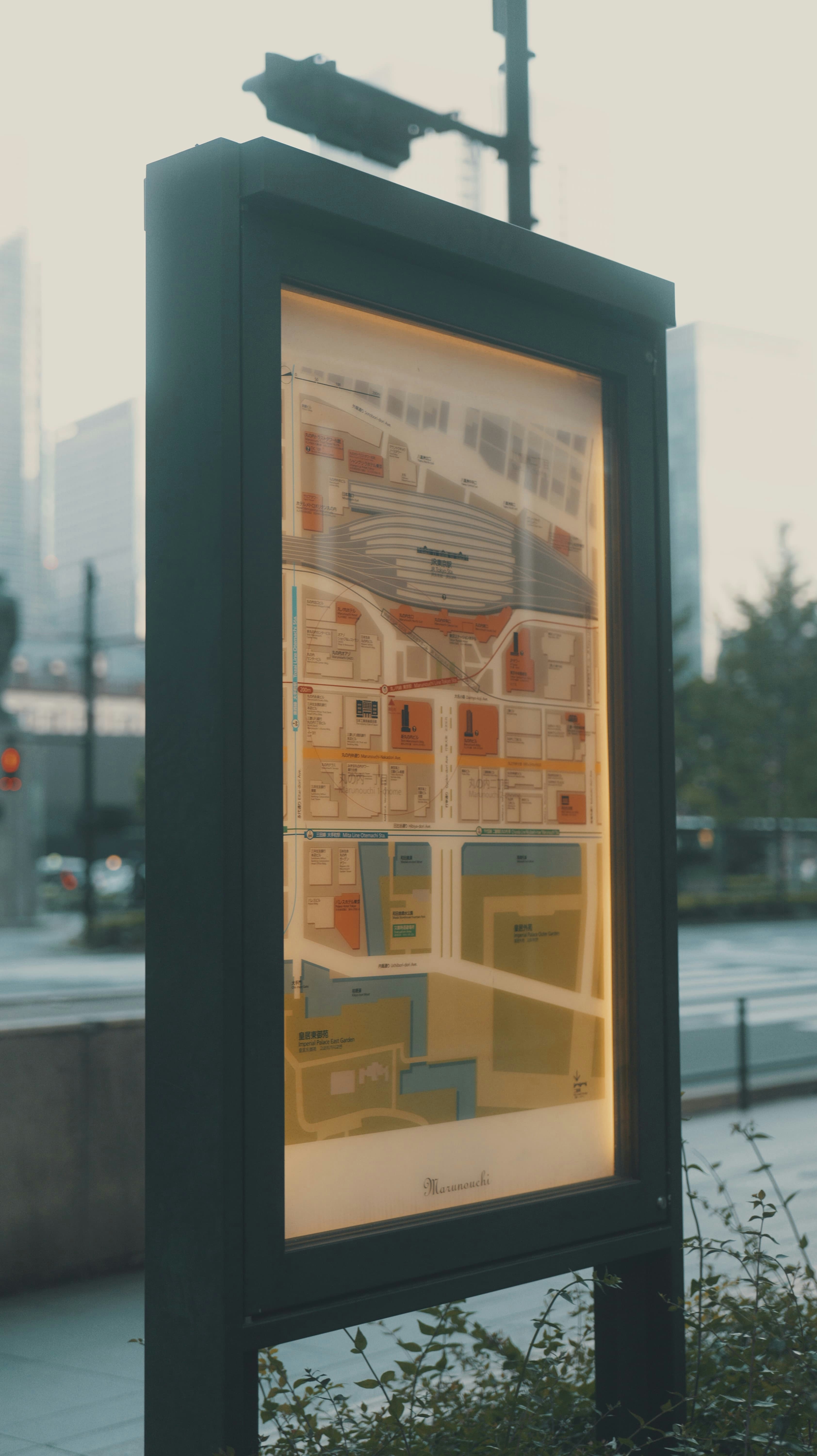 A sign with a picture of a city on it photo – Free Marunouchi building ...