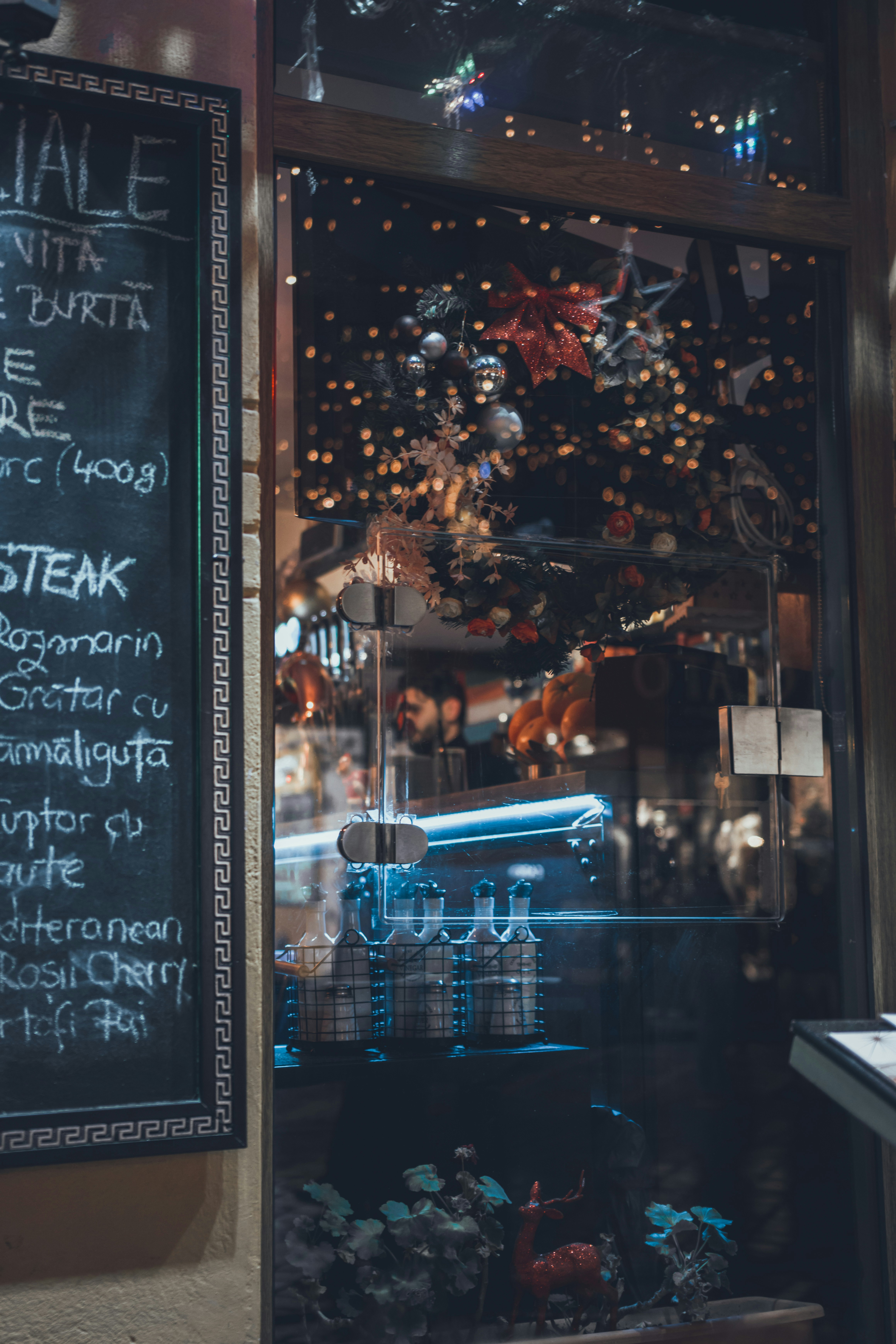 Twinkling Glass Door Reflections in a Festive Café Window