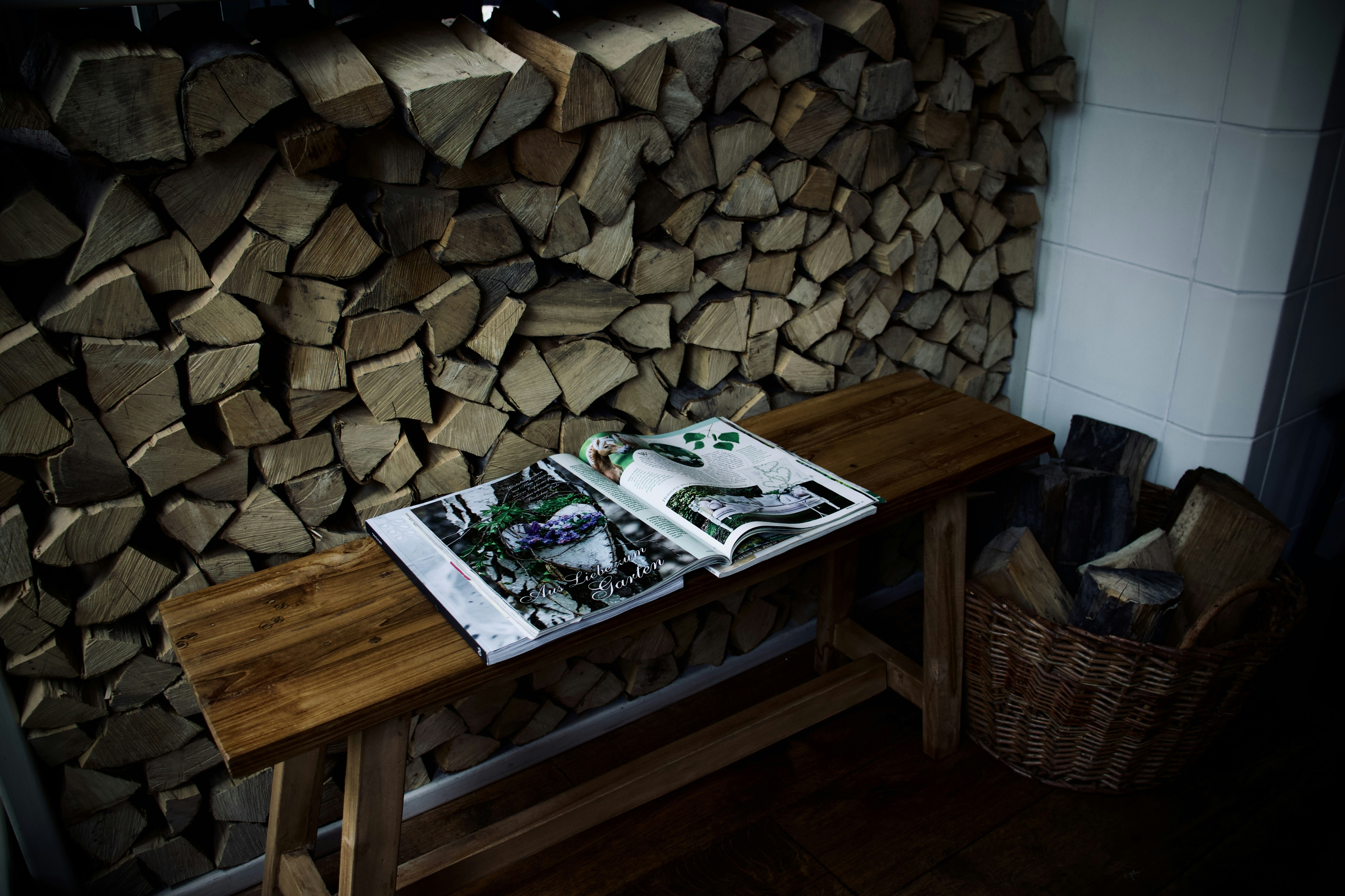 Green Pages on a Lumber Bench in a Dim Firewood Nook