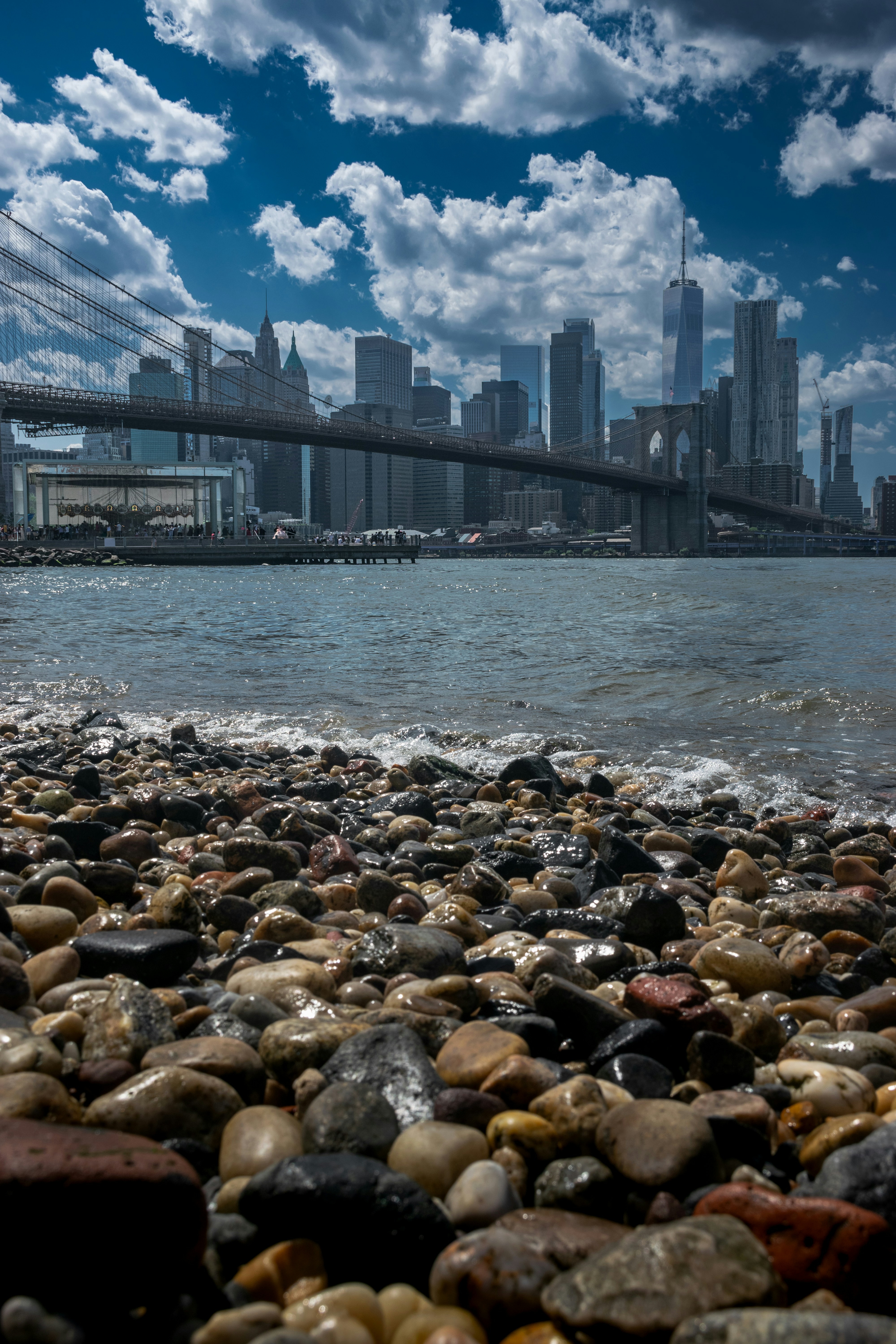 Pebble Shoreline to Skyline: Brooklyn Bridge Framing Manhattan's Horizon