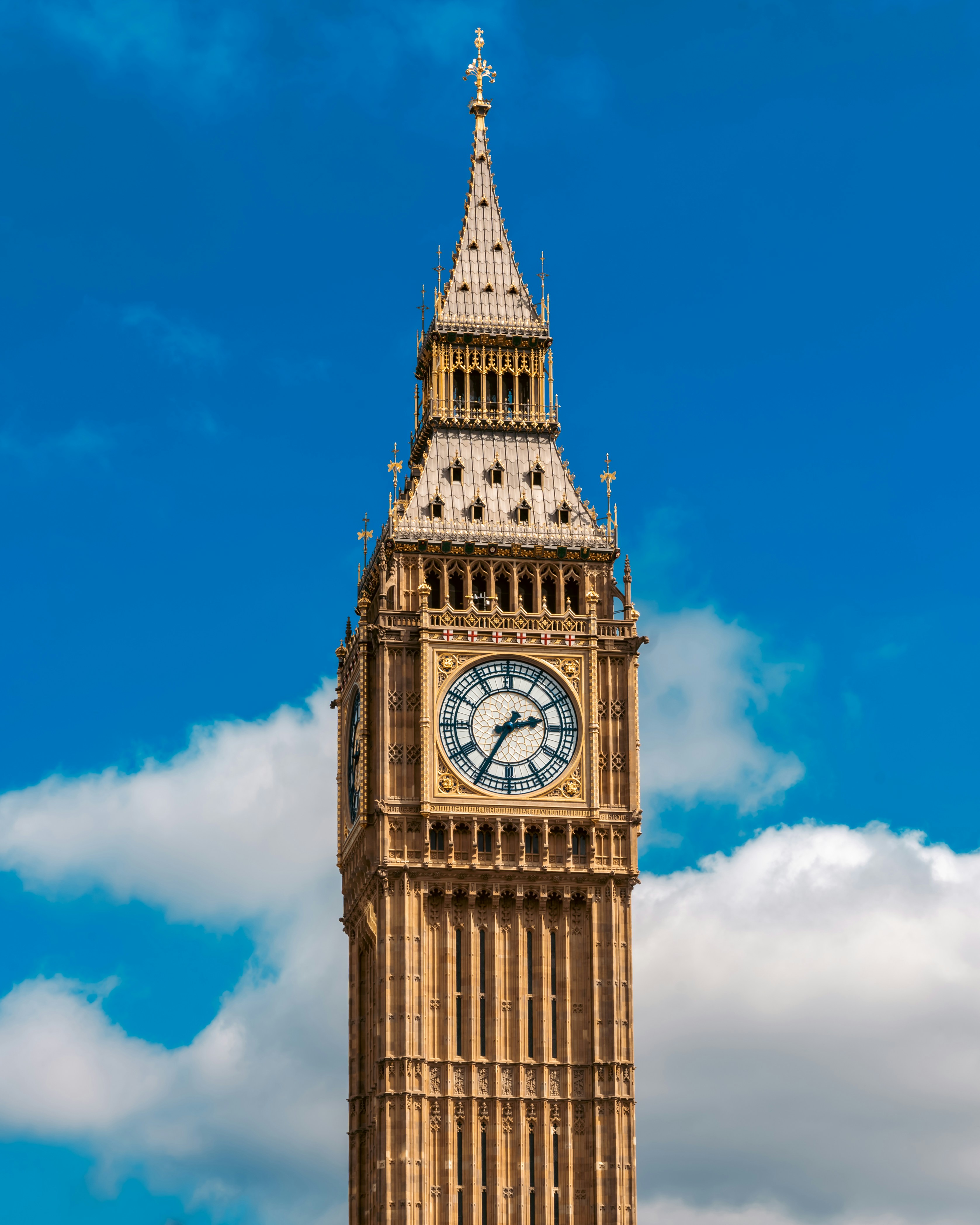 A clock tower with a blue sky in the background photo – Free London ...