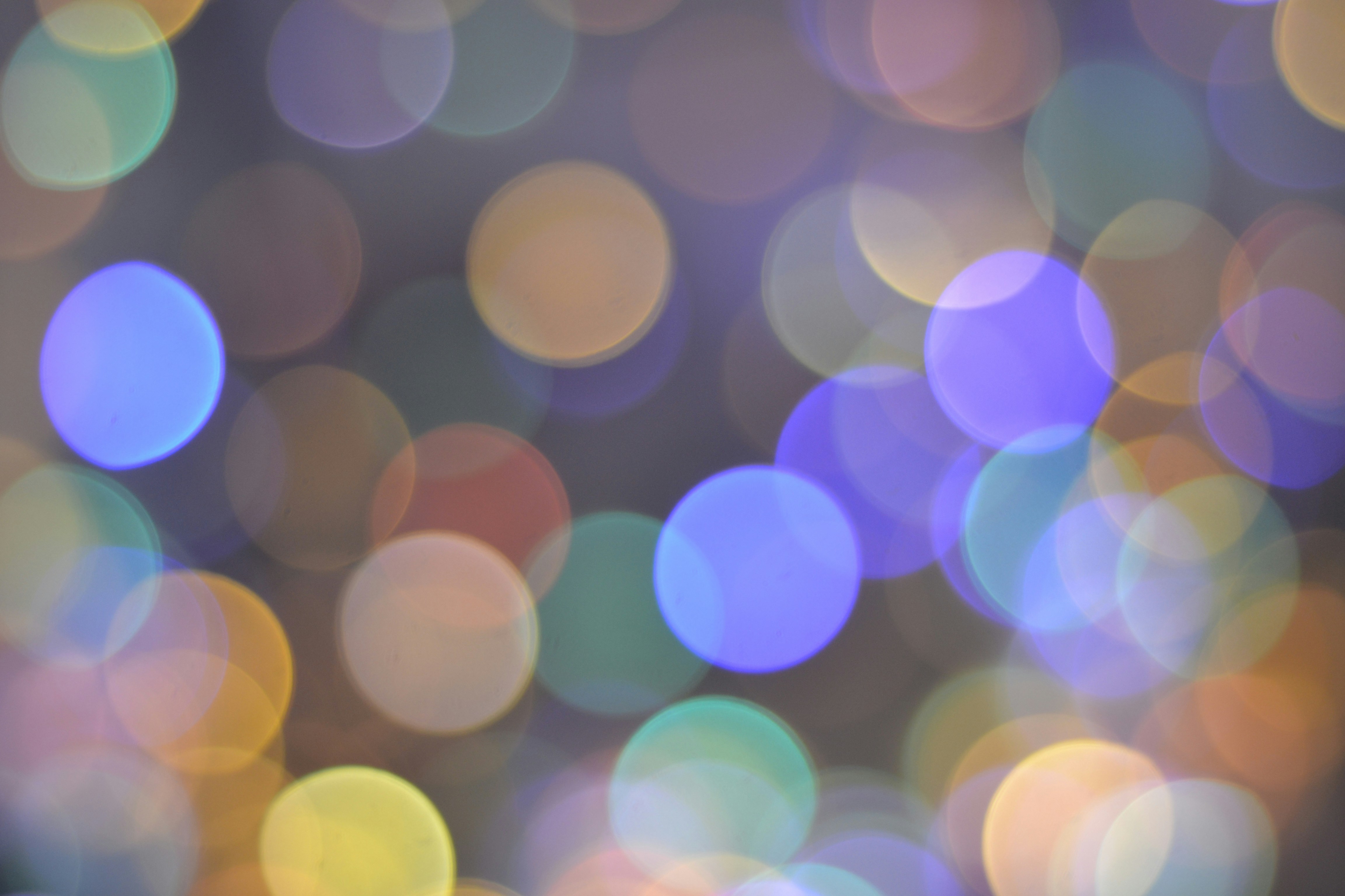 Abstract bokeh effect showcasing a blend of vibrant circular lights in various colors. The soft focus creates a dreamy atmosphere.