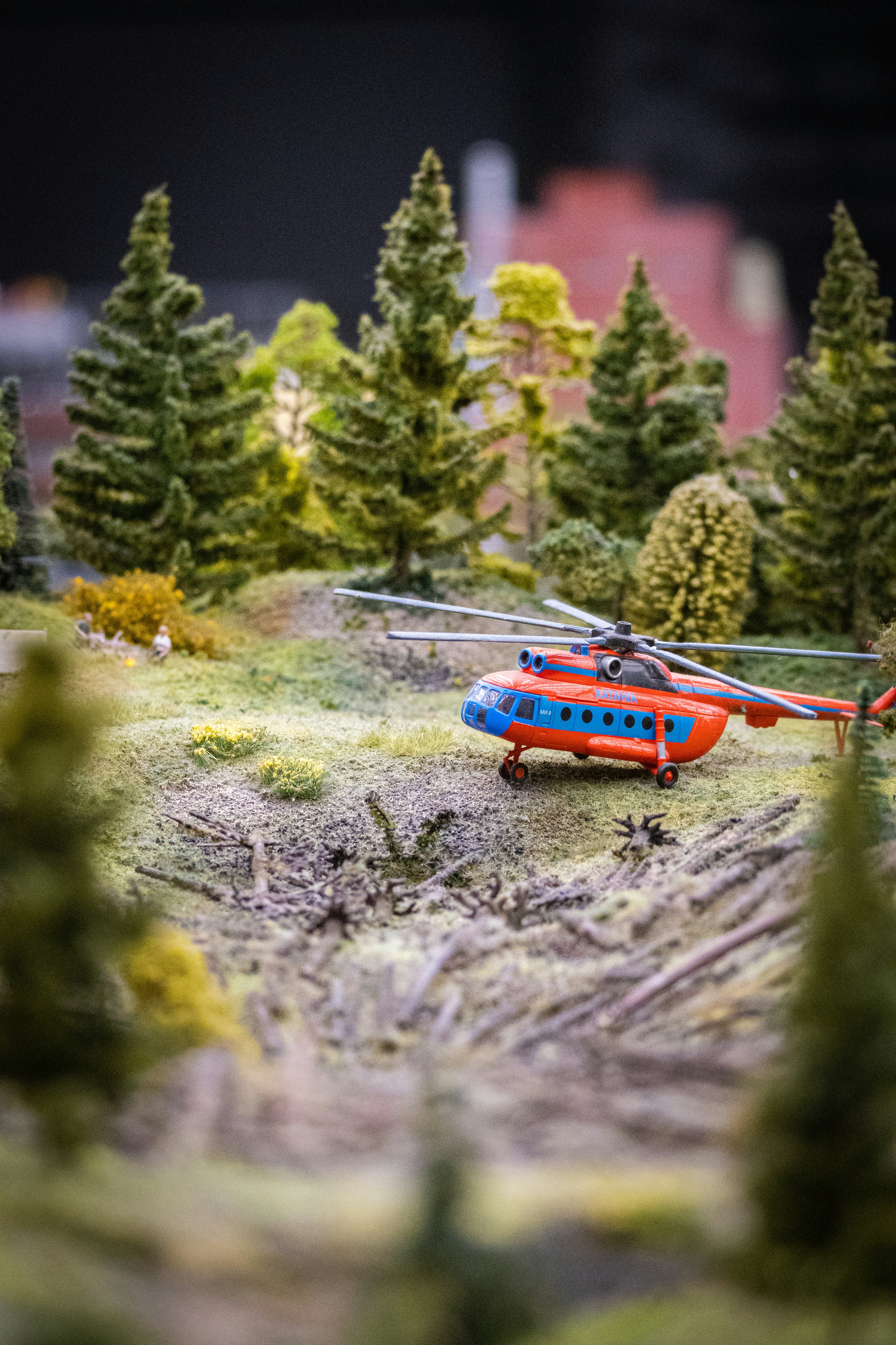 Orange-Blue Helicopter in a Miniature Forest Scene