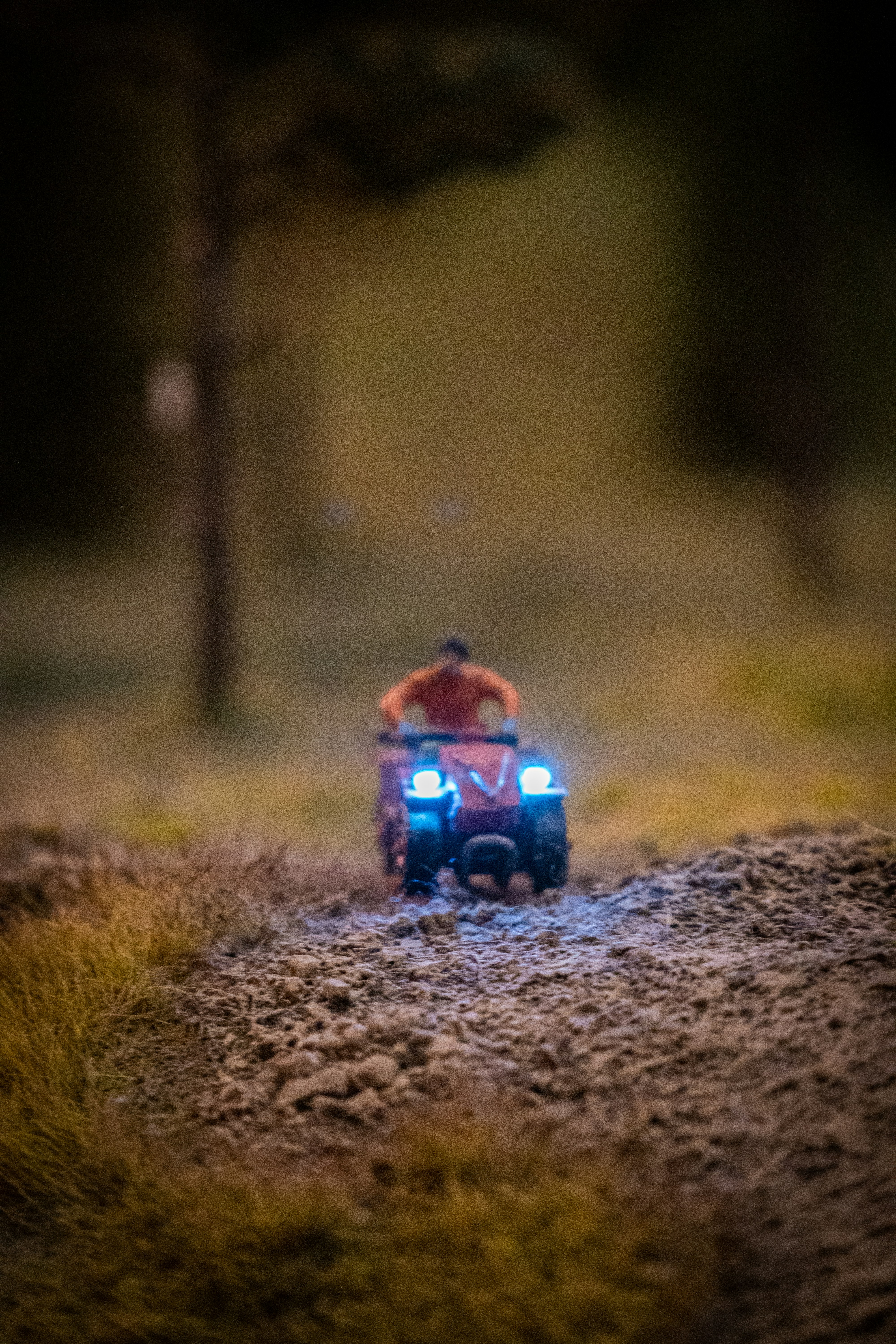 Tiny Rider, Blue-Glow Trail on a Moonlit Gravel Path