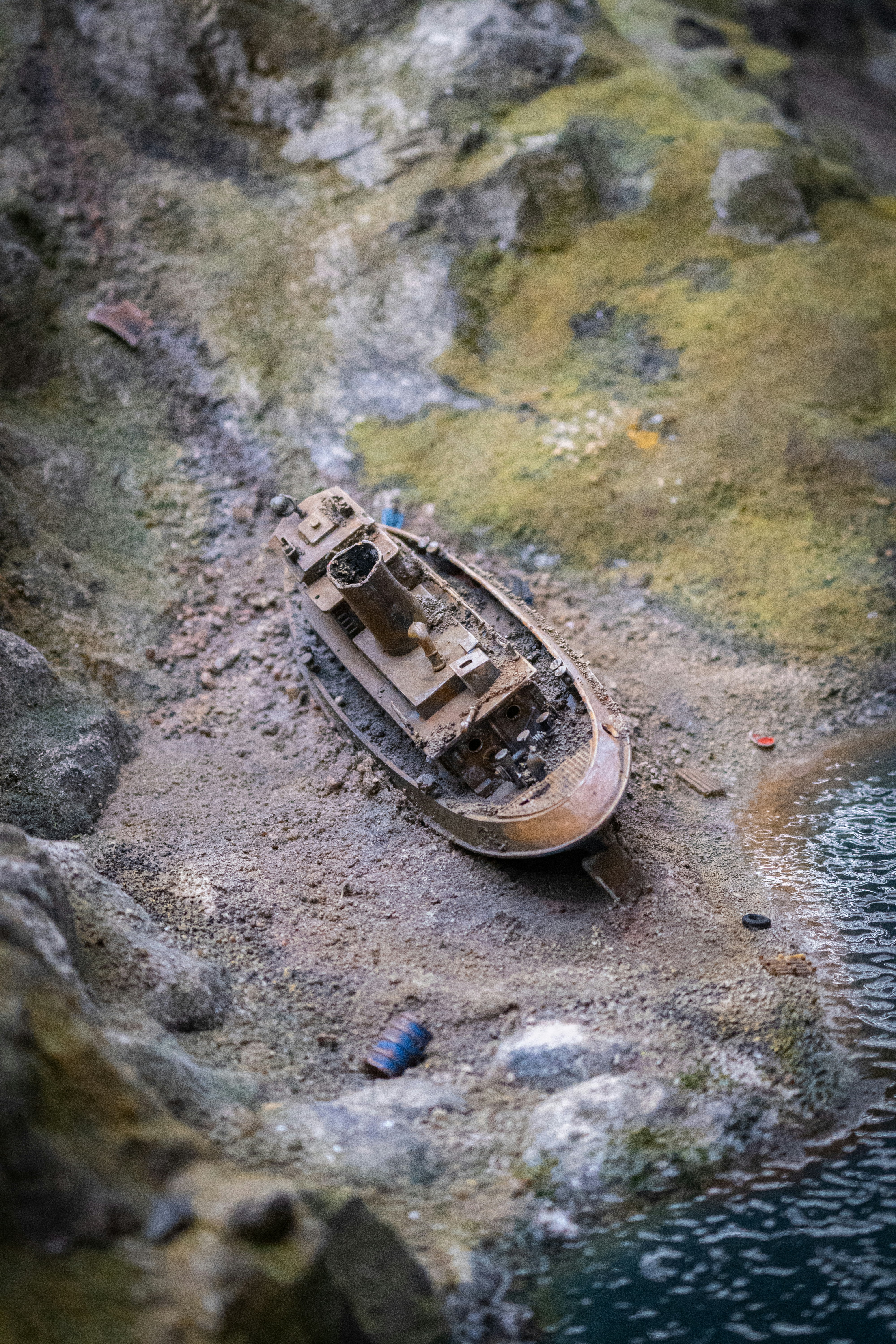 Moss-Wrapped Miniature Wreck on a Rocky Shore