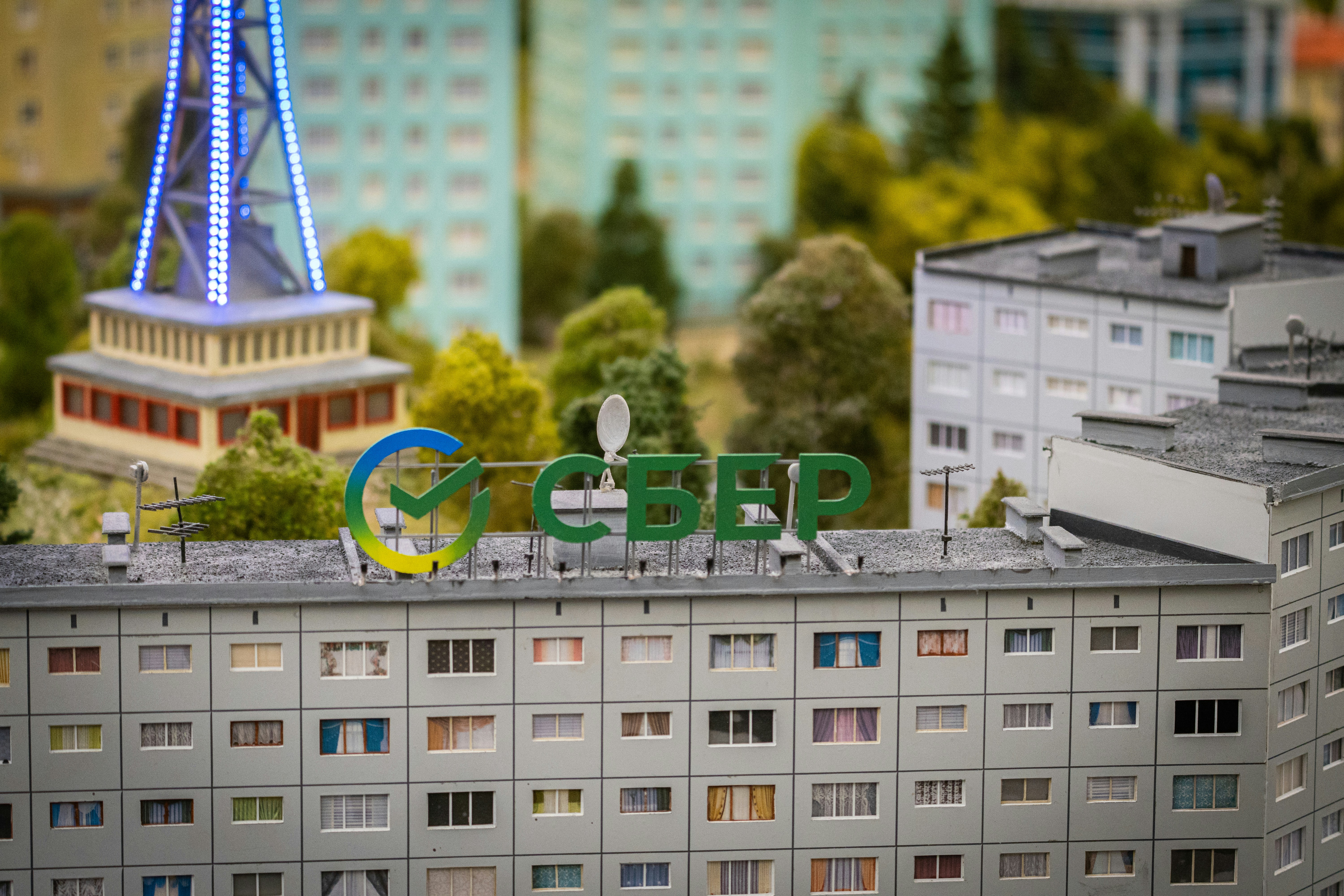Rooftop SBER Sign Anchoring a Detailed Miniature Cityscape
