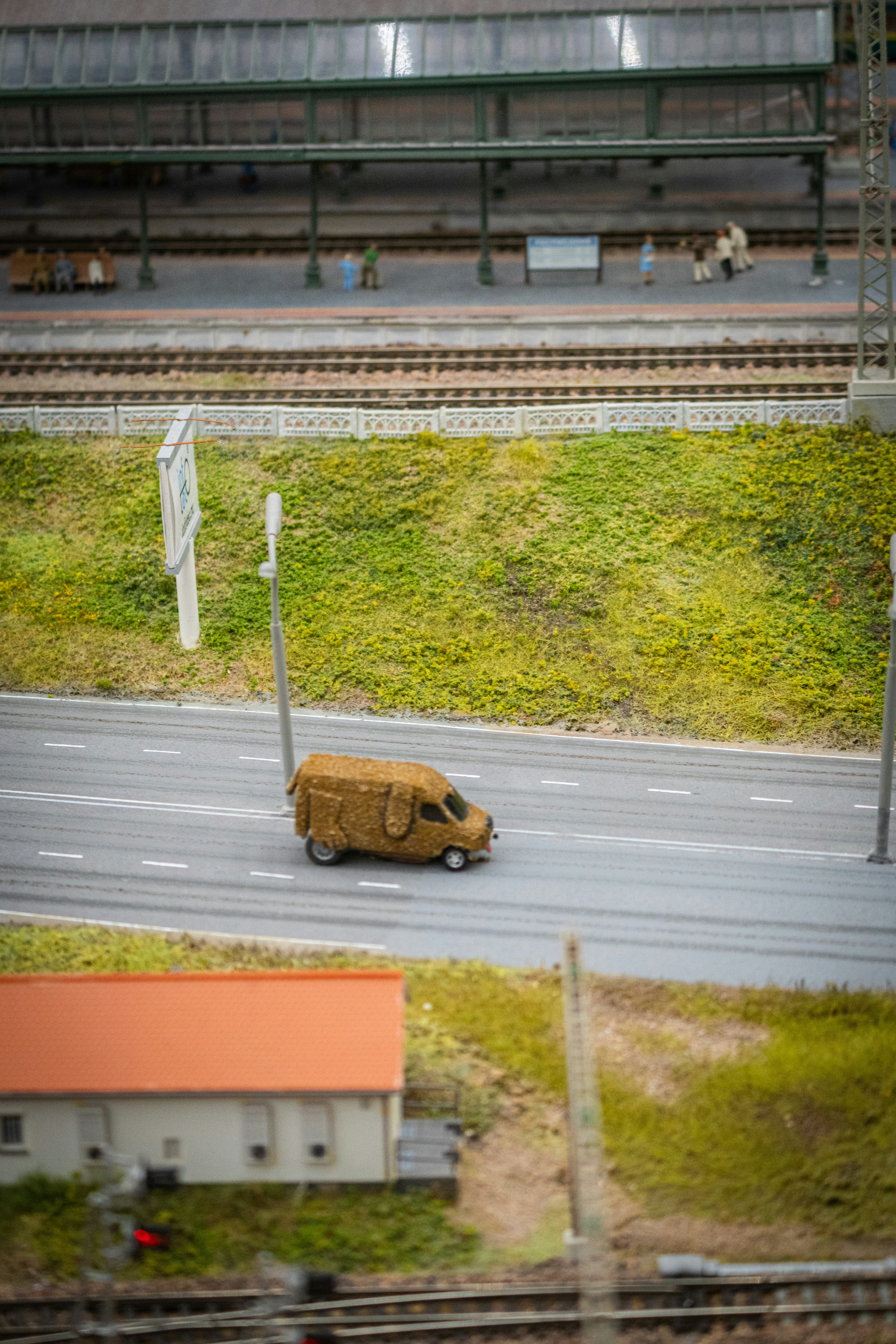 Tilt-Shift Highway: A Fuzzy Brown Truck Traverses a Quiet Diorama