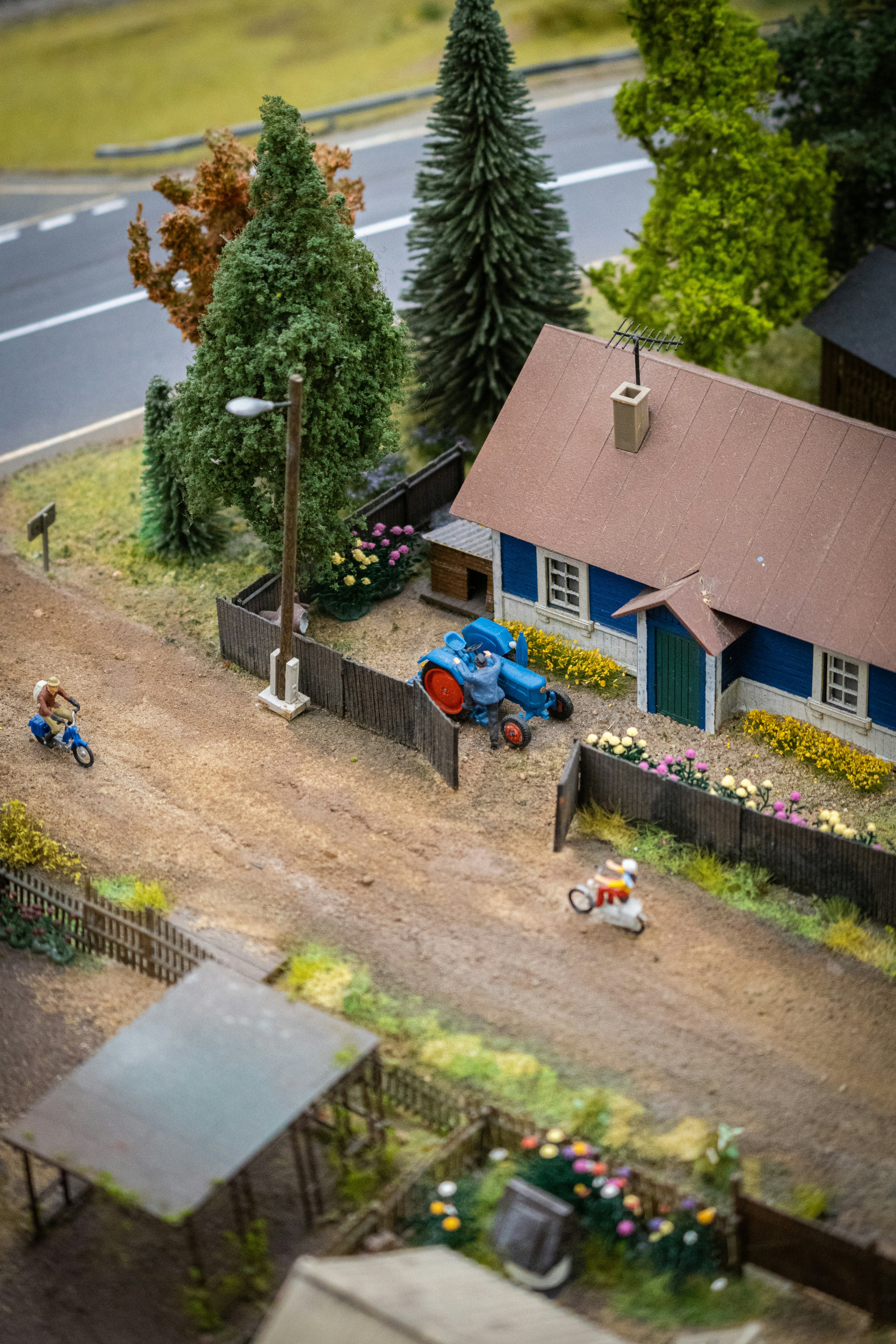 Miniature Farmstead: Blue Tractor by the Cottage on a Curving Road