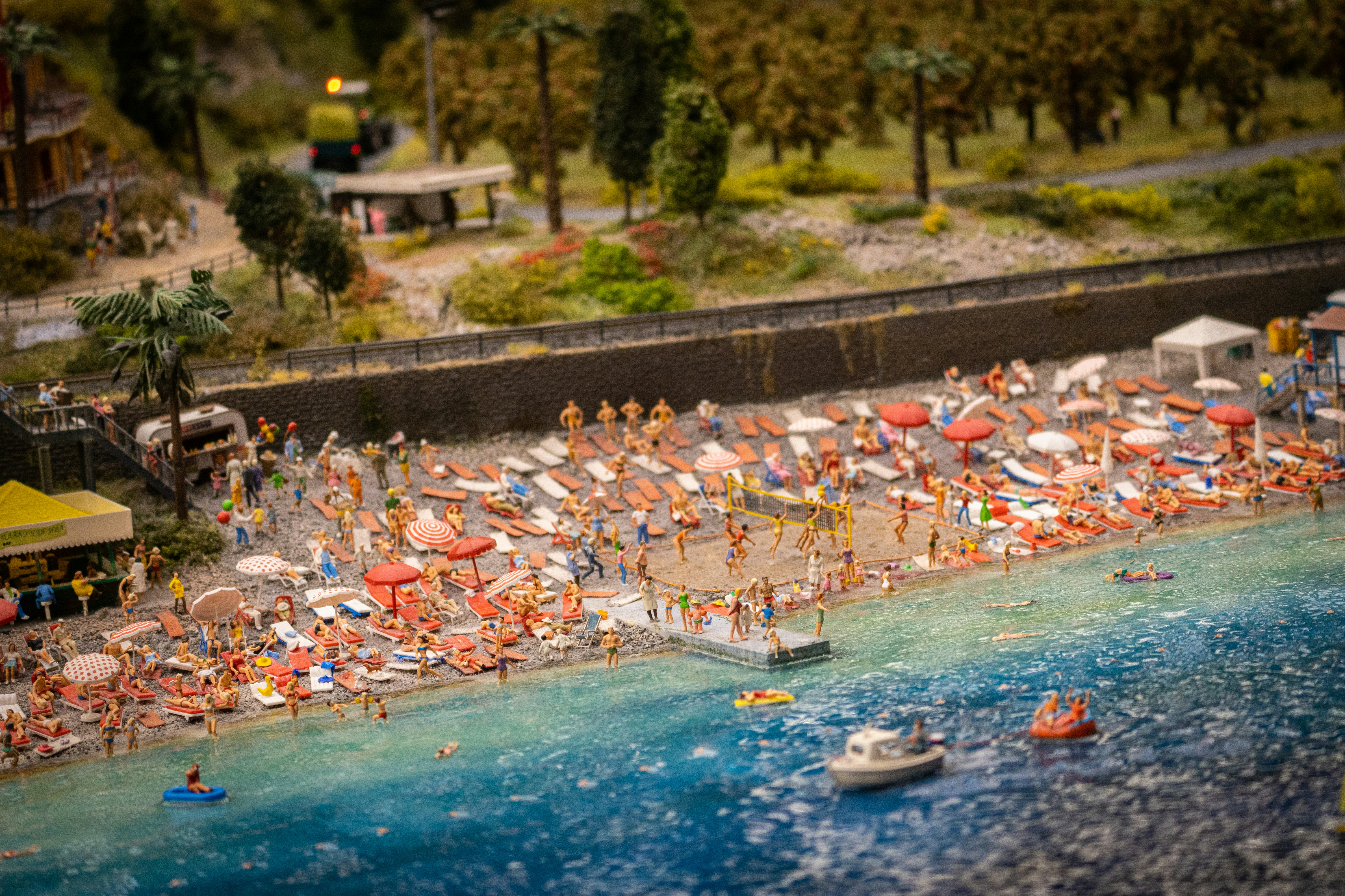 Sunlit Micro-Beach: A Crowded Diorama of Umbrellas and Tiny Beachgoers