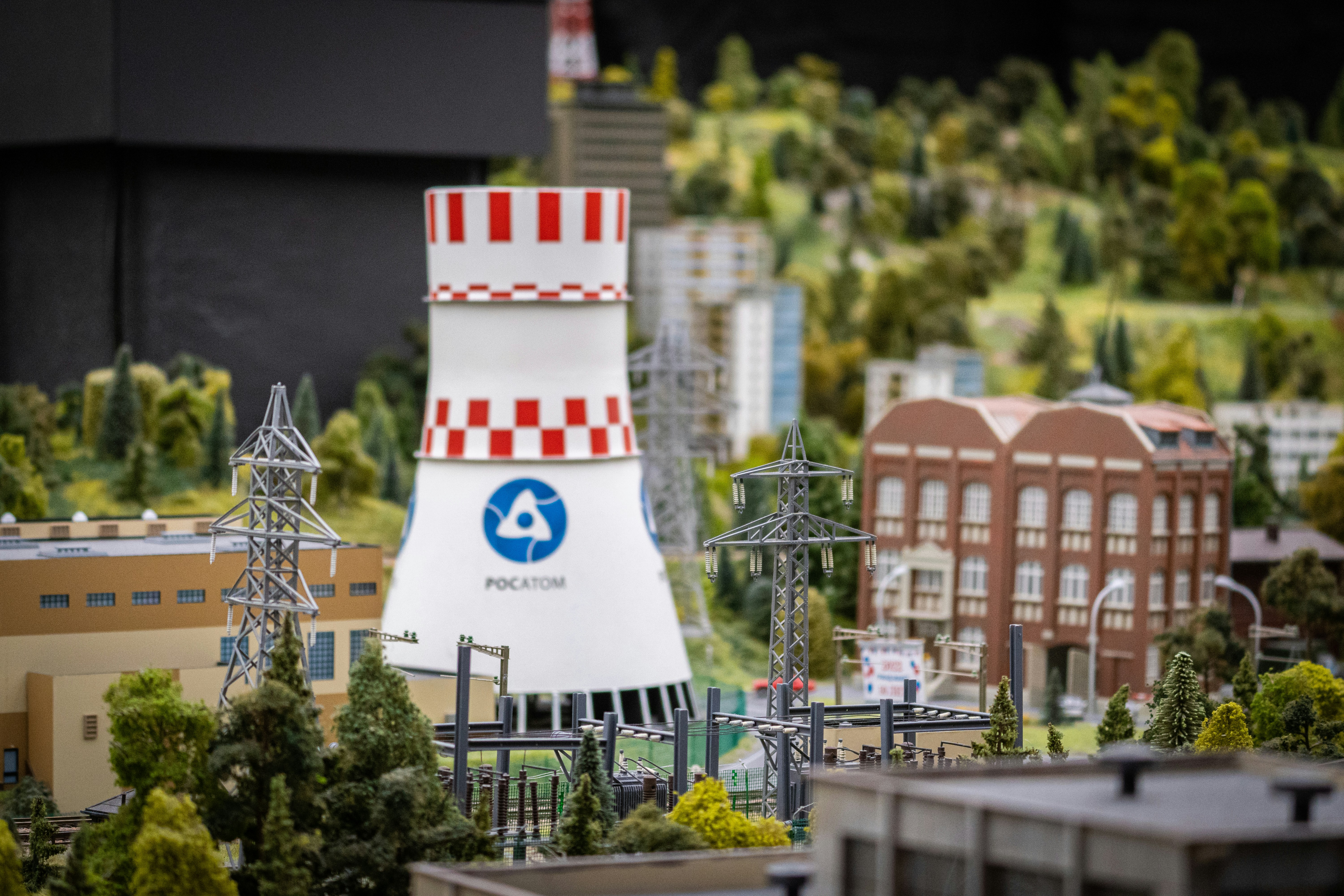 Scale City Under Construction: A Miniature Industrial Landscape with a Striped Cooling Tower