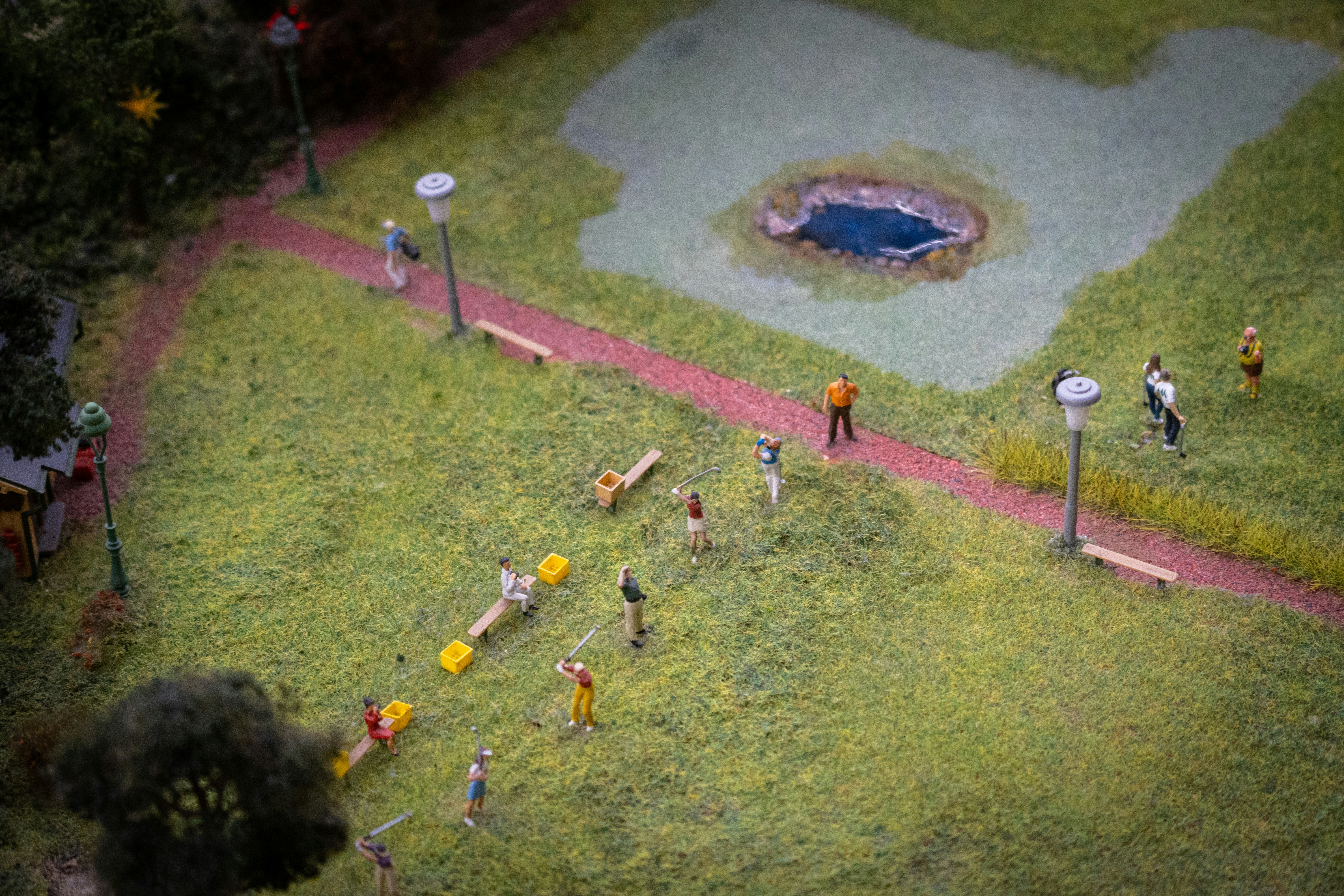A miniature model of a park with people playing frisbee golf photo ...
