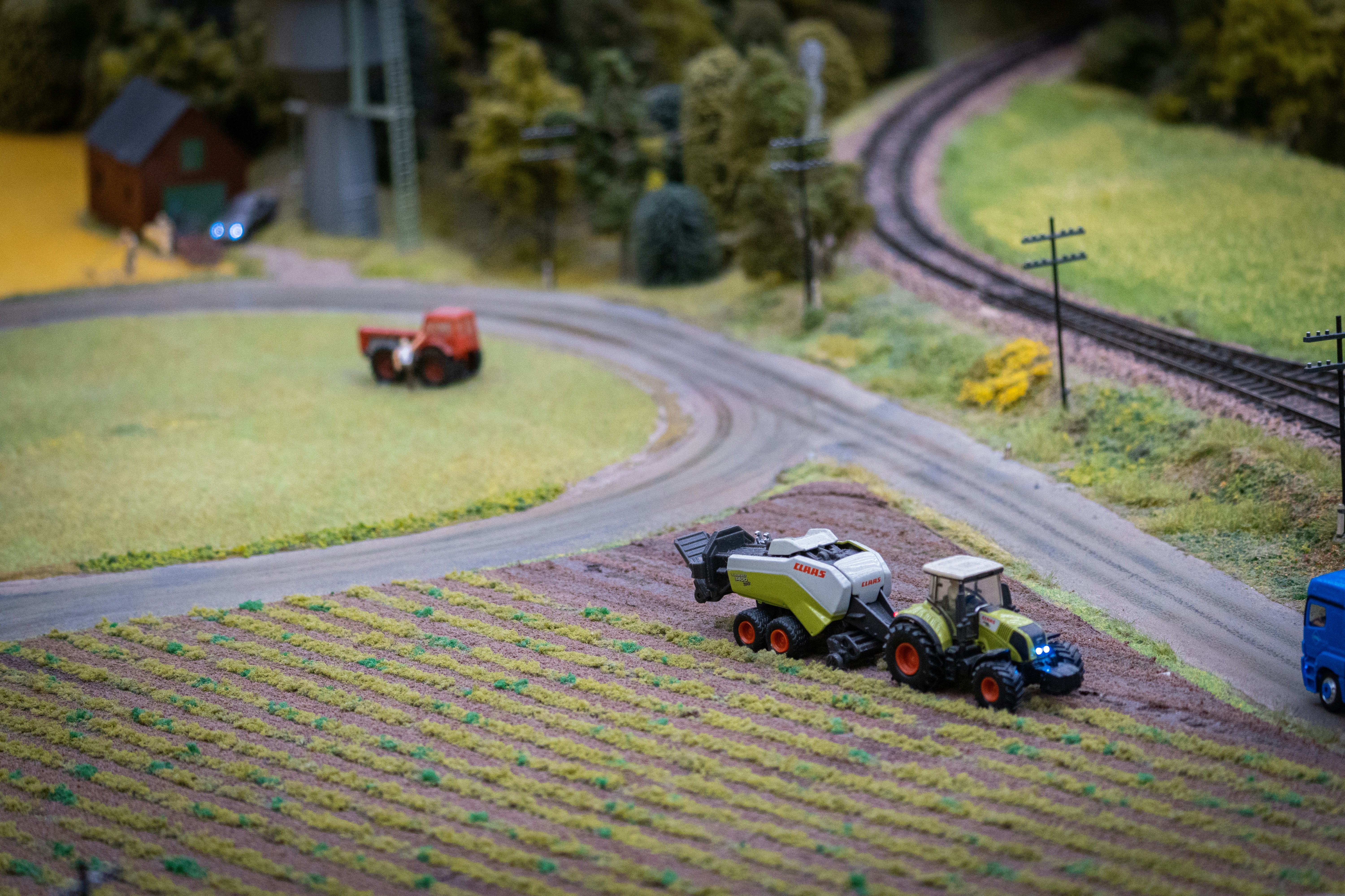 A toy farm scene with a tractor and tractor trailer photo – Free Car ...