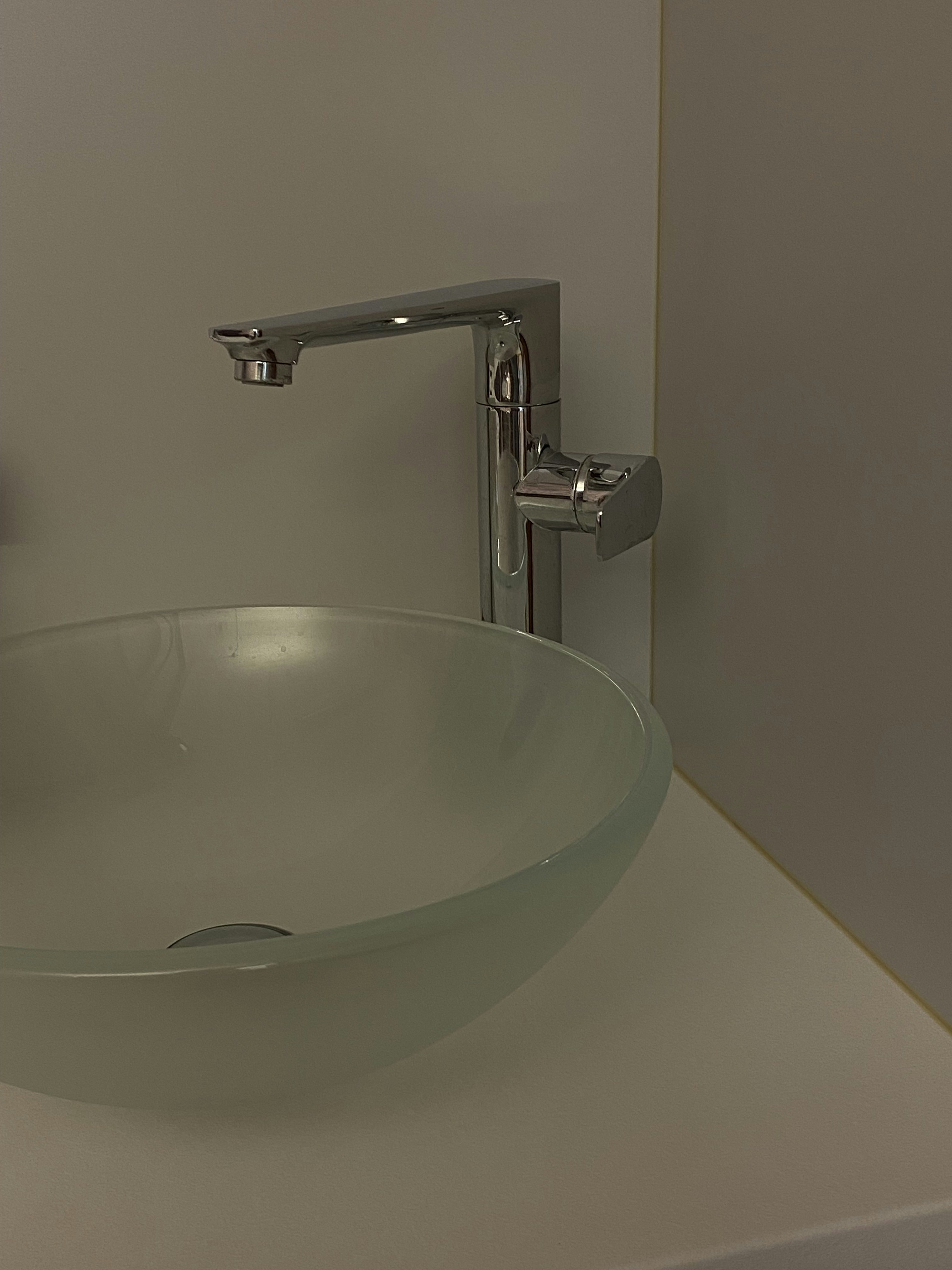 Chrome Confluence: A Quiet Bathroom Sink Under Ambient Glow