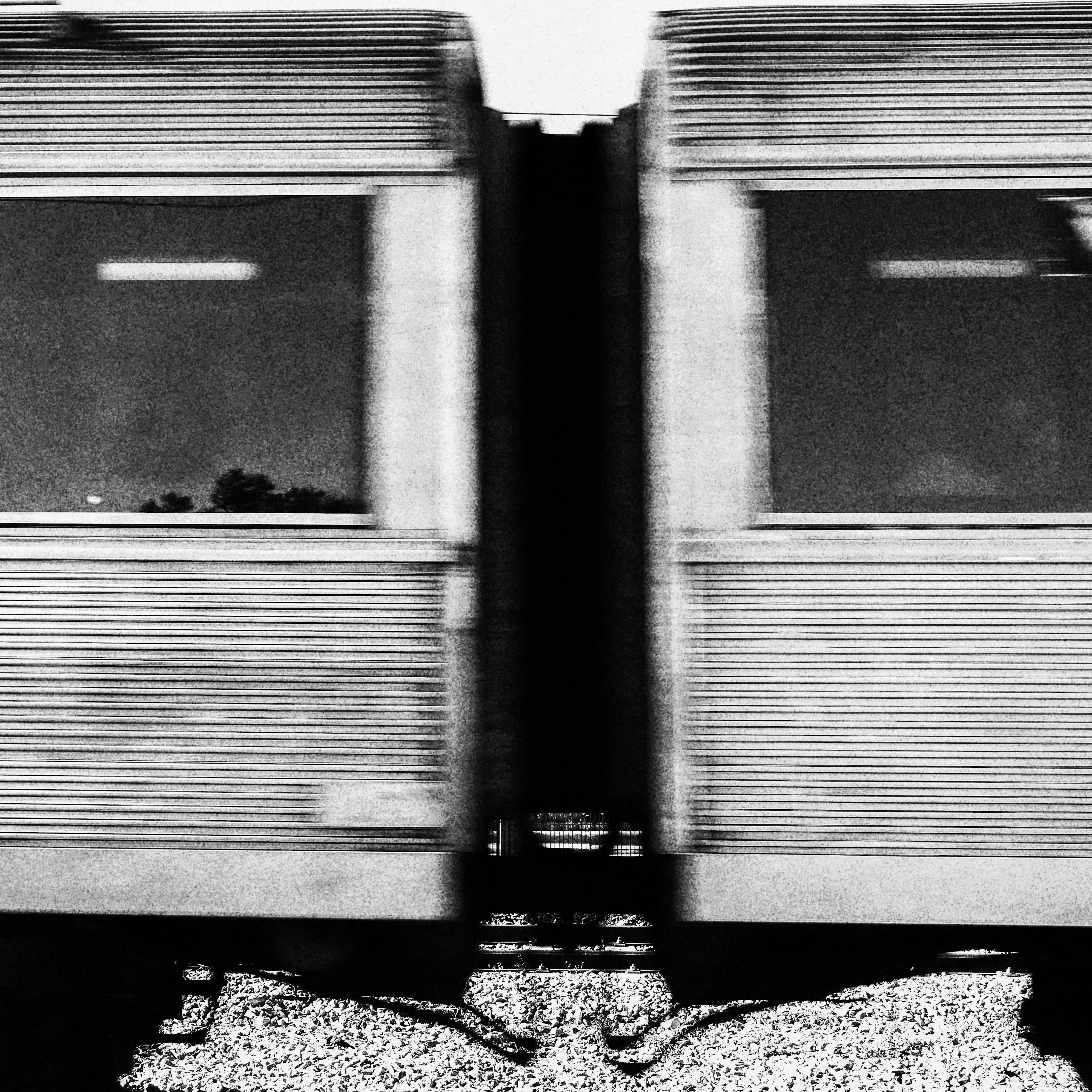 Split Between Rails: Grainy Monochrome Symmetry of Twin Railcars