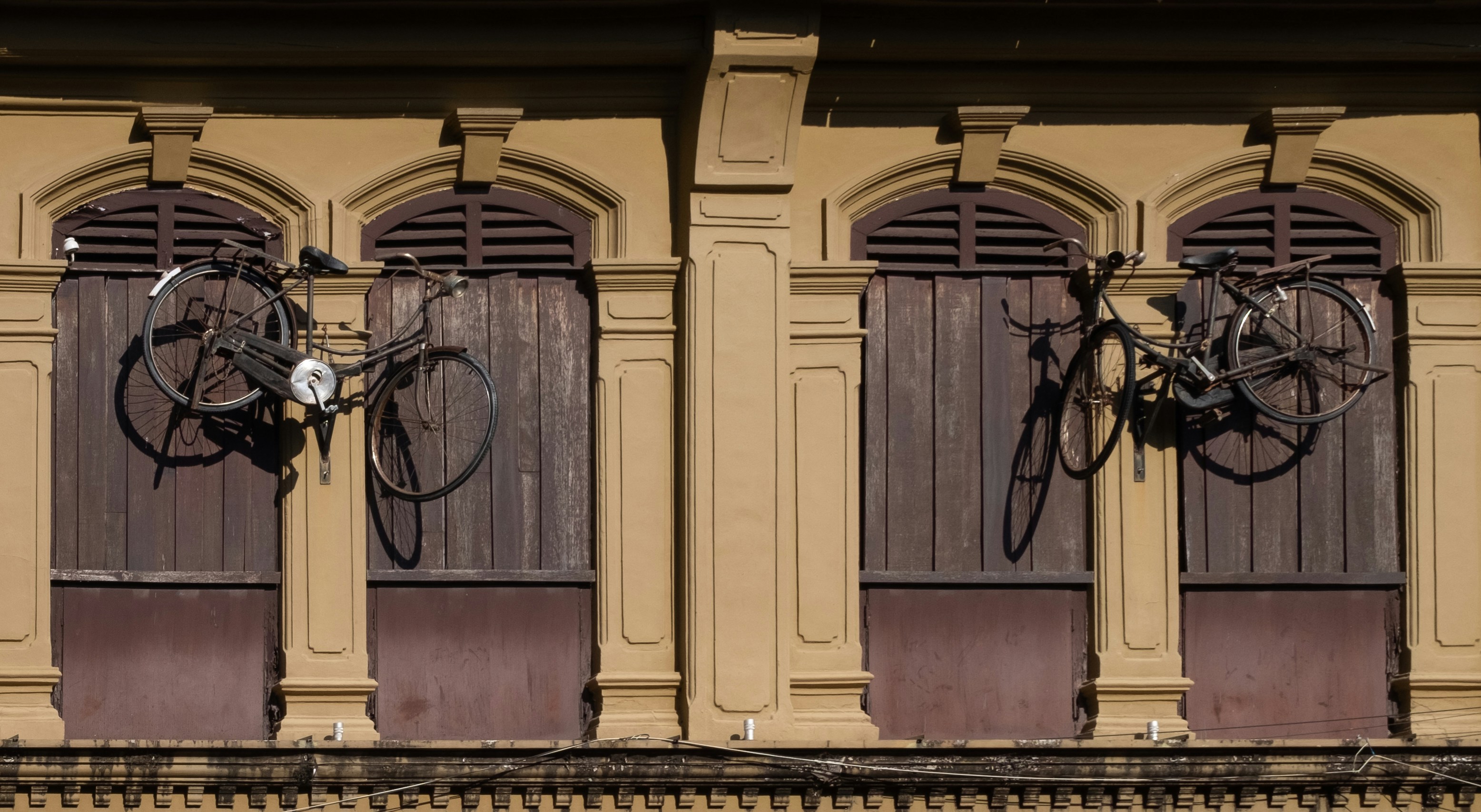 Twin Bicycles Framing a Historic Facade