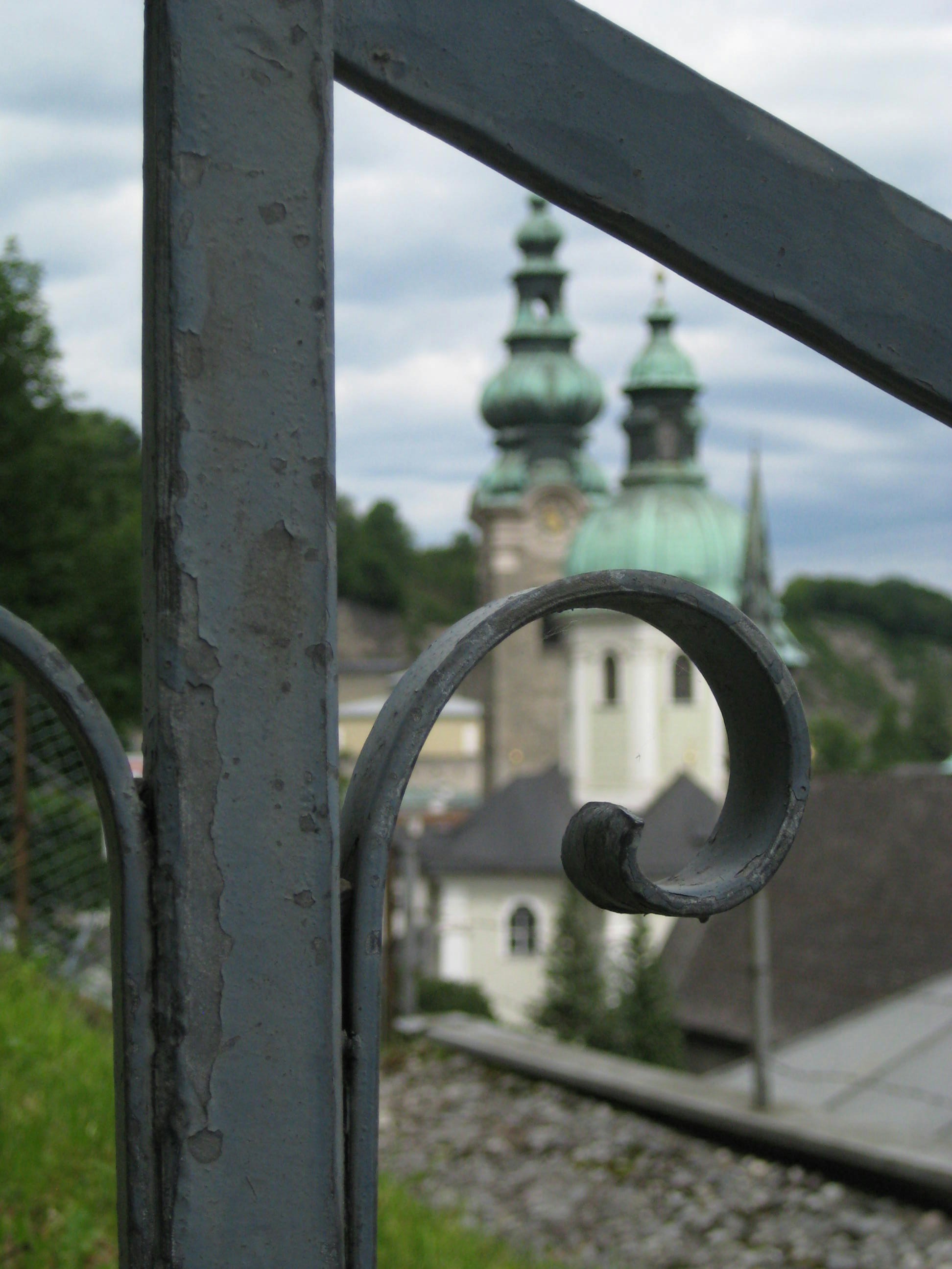 a metal gate with a building in the background
