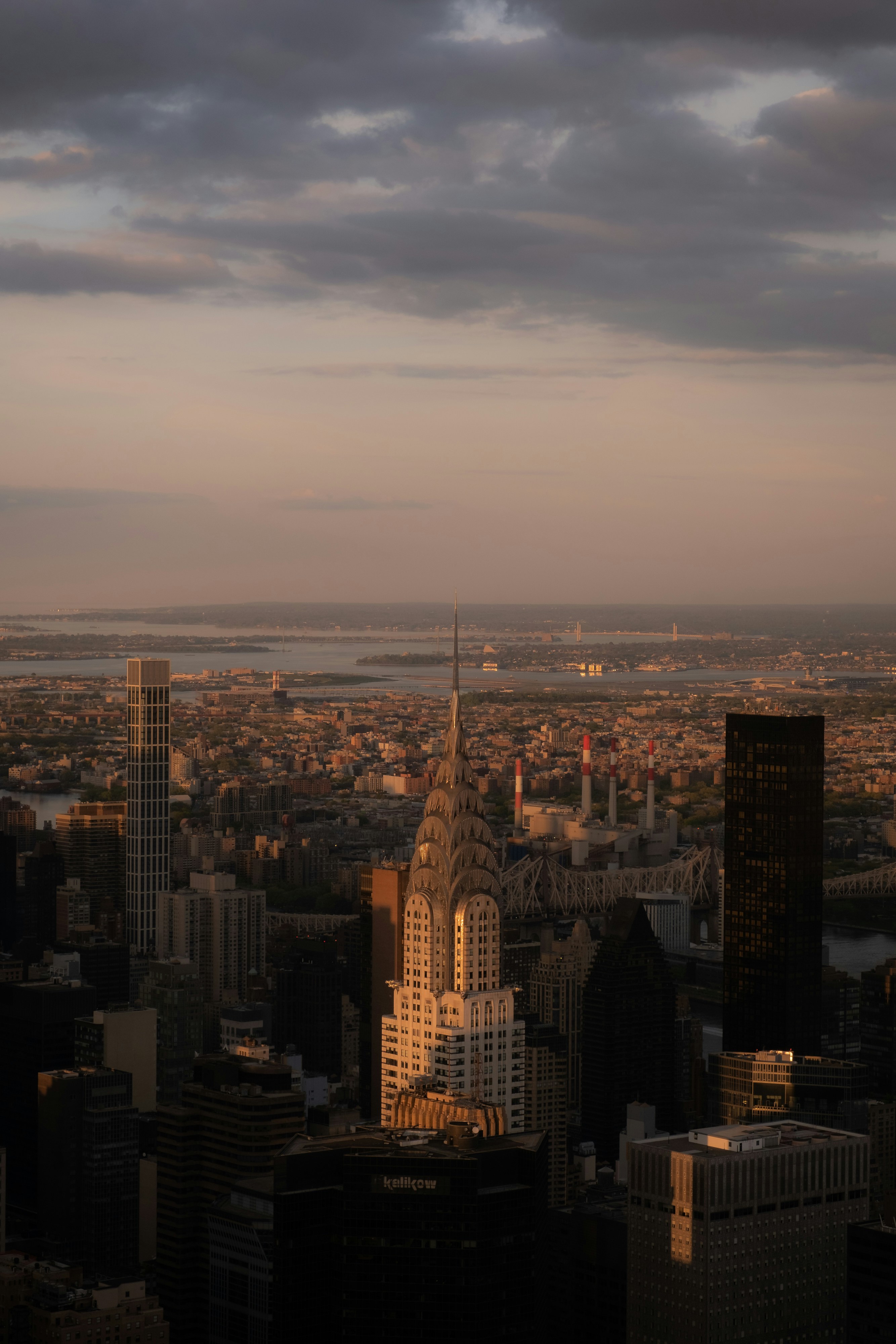 Chrysler’s Silhouette at Golden Hour over a City’s Spine