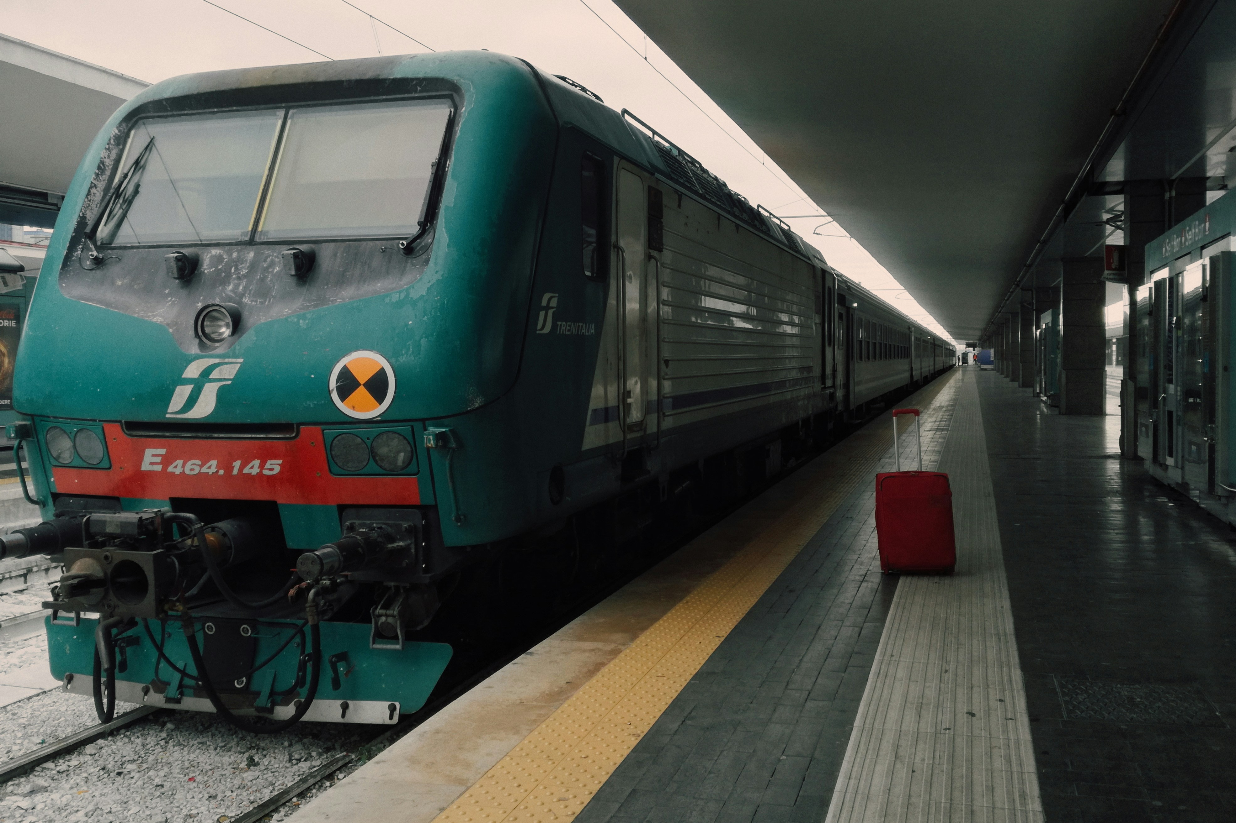 A green train pulling into a train station photo – Free Napoli Image on ...