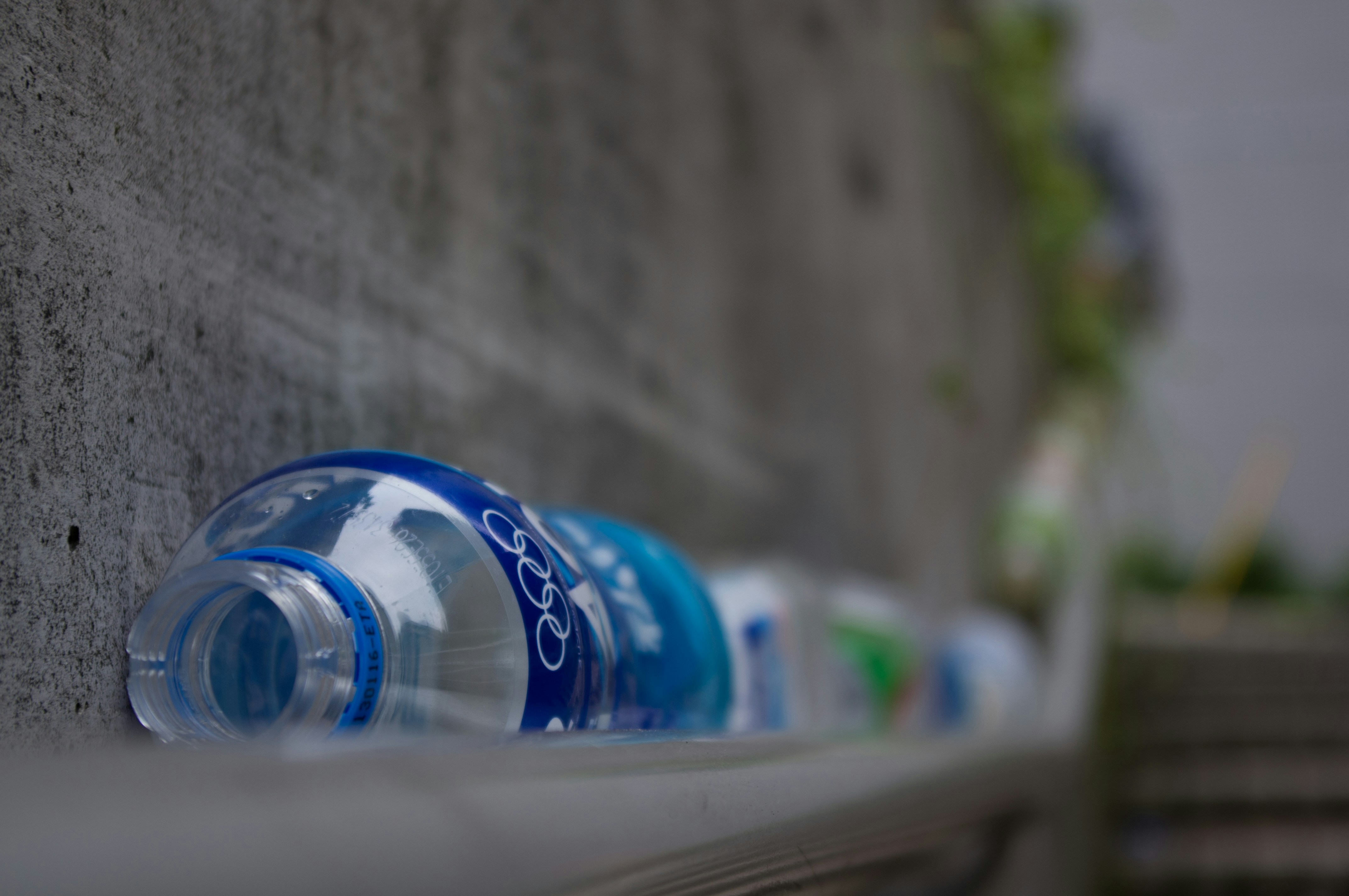 A row of water bottles sitting on the side of a building photo – Free ...