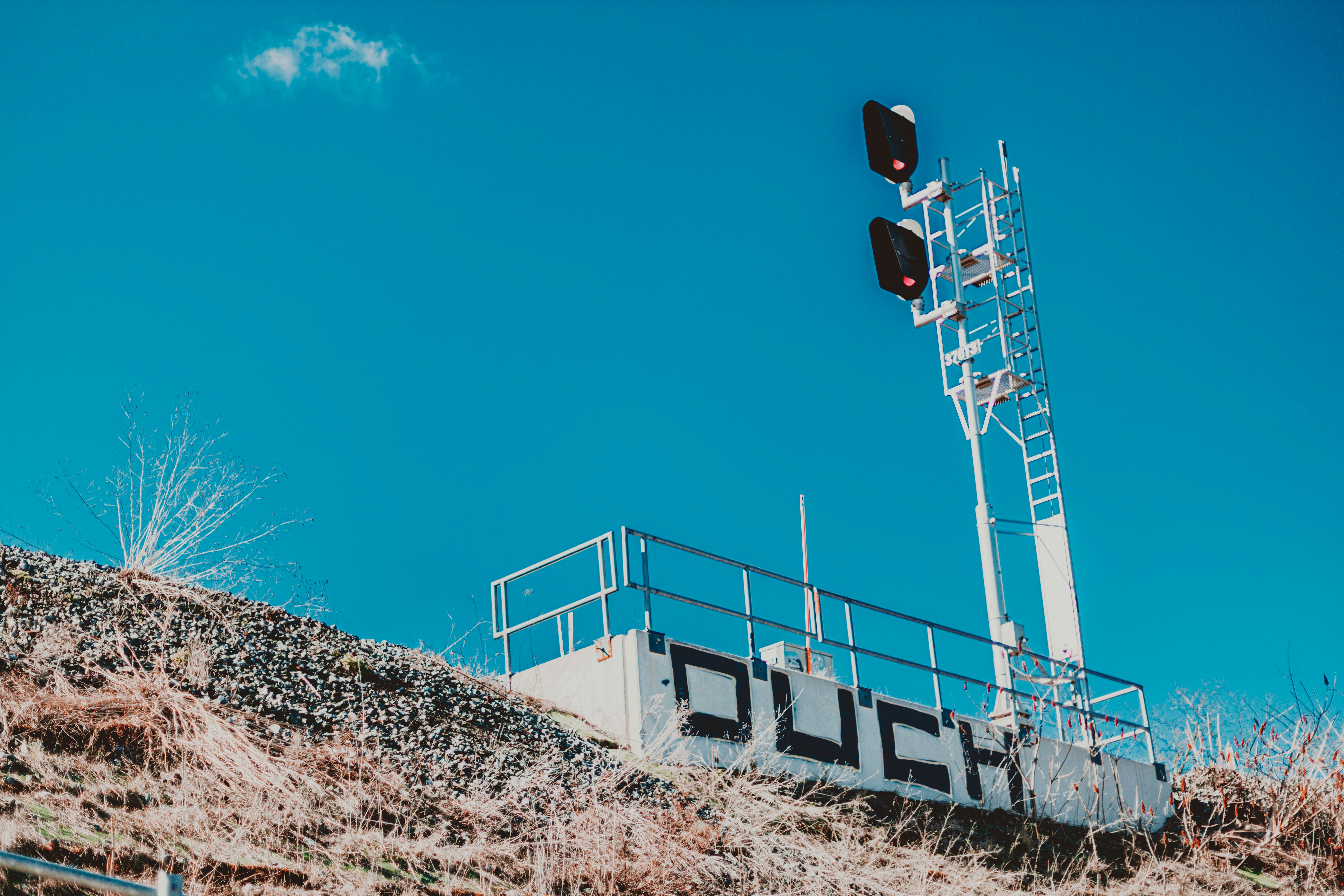 a traffic light sitting on top of a hill