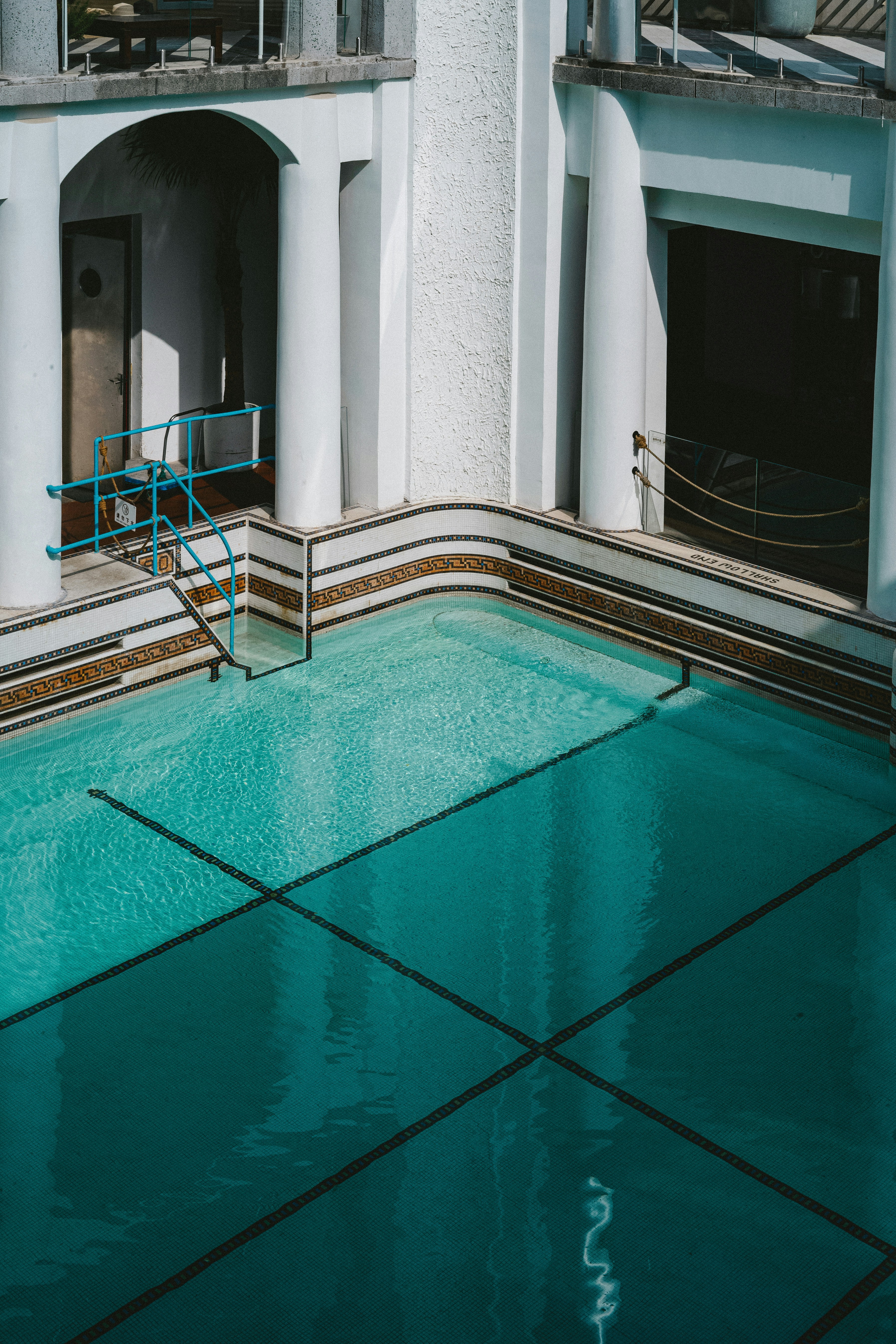 An empty swimming pool in front of a building photo – Free Pool Image ...
