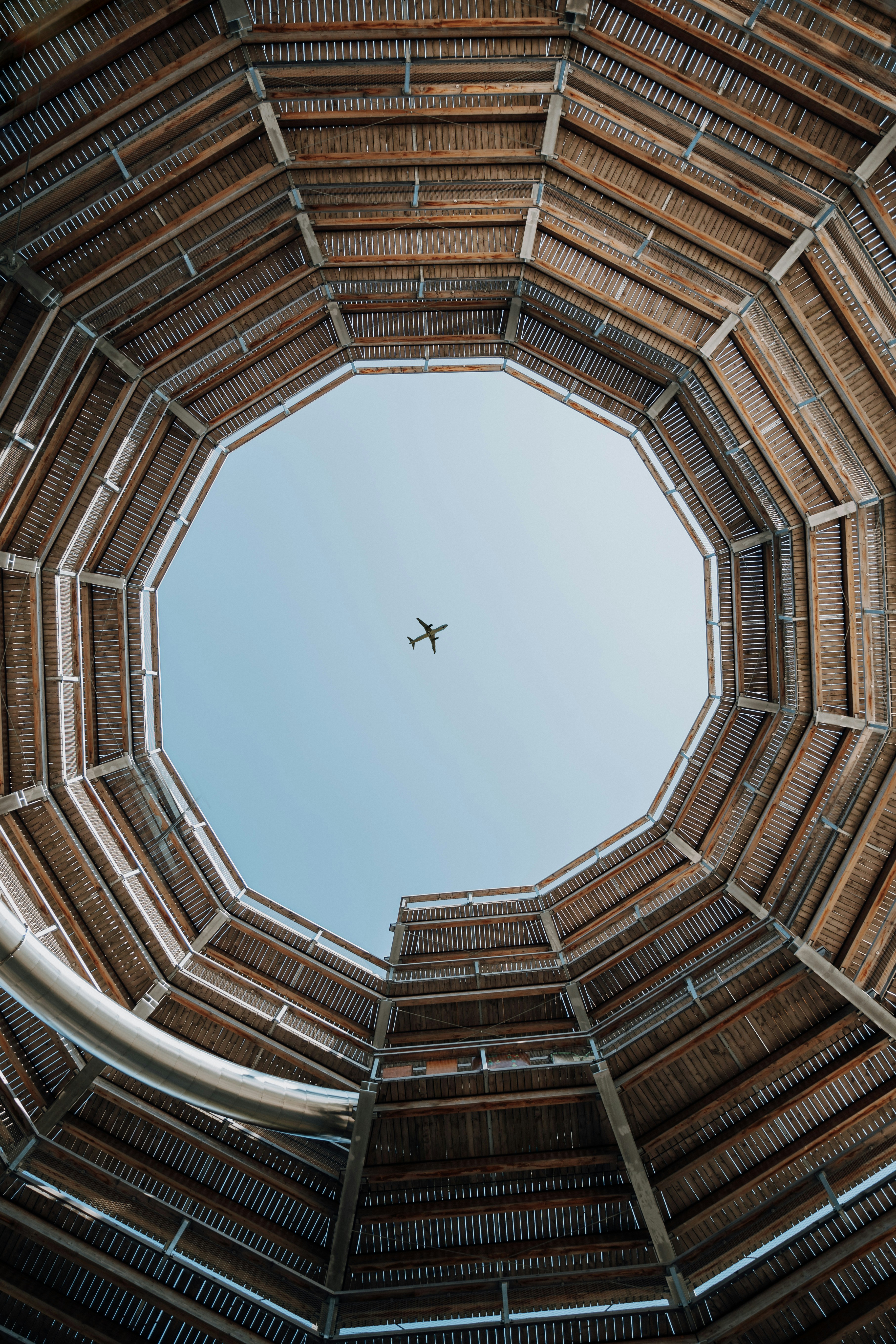 Foto Un avión volando en el cielo a través de una estructura de madera ...