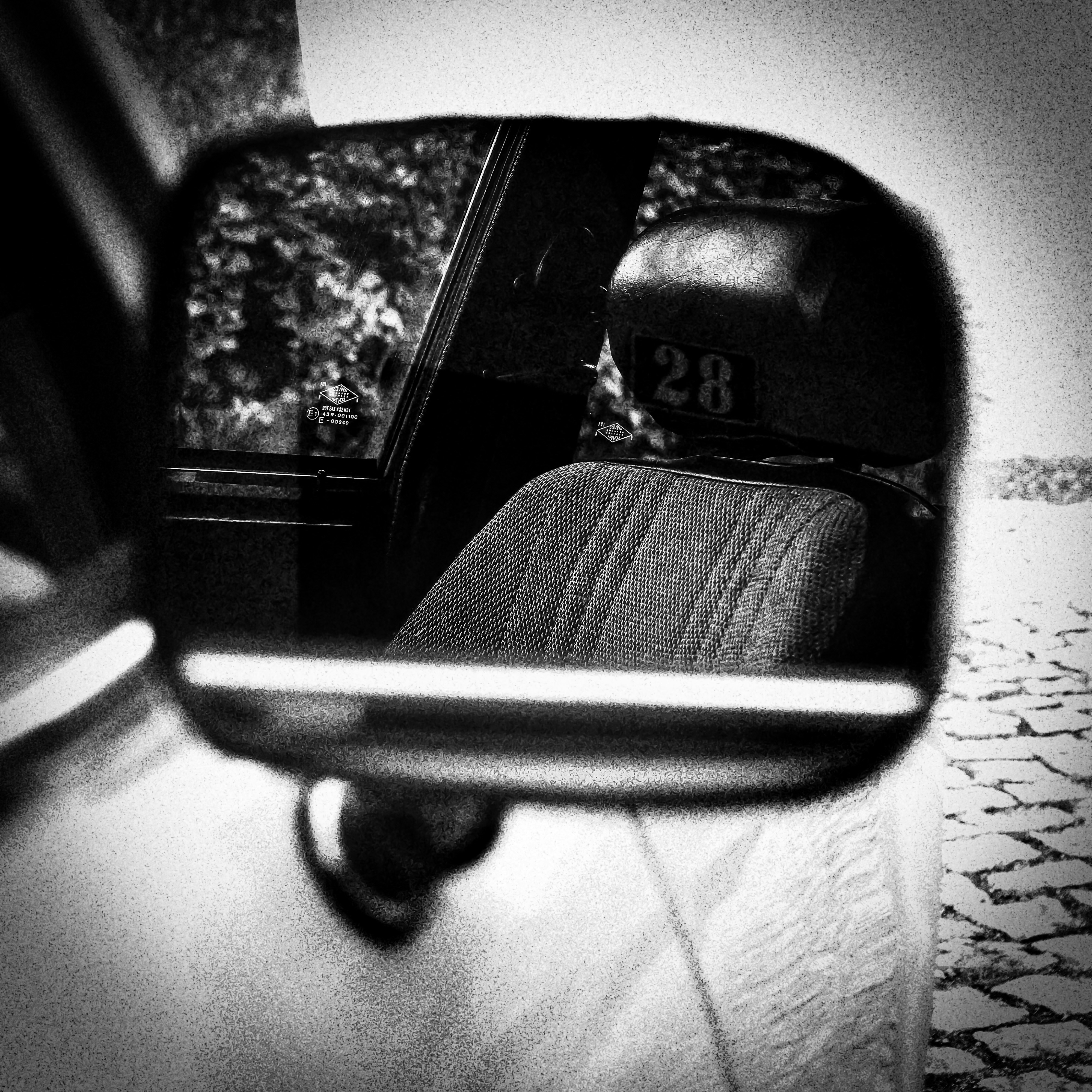 Glass and Grain: Quiet Reflection in a Black-and-White Side Mirror