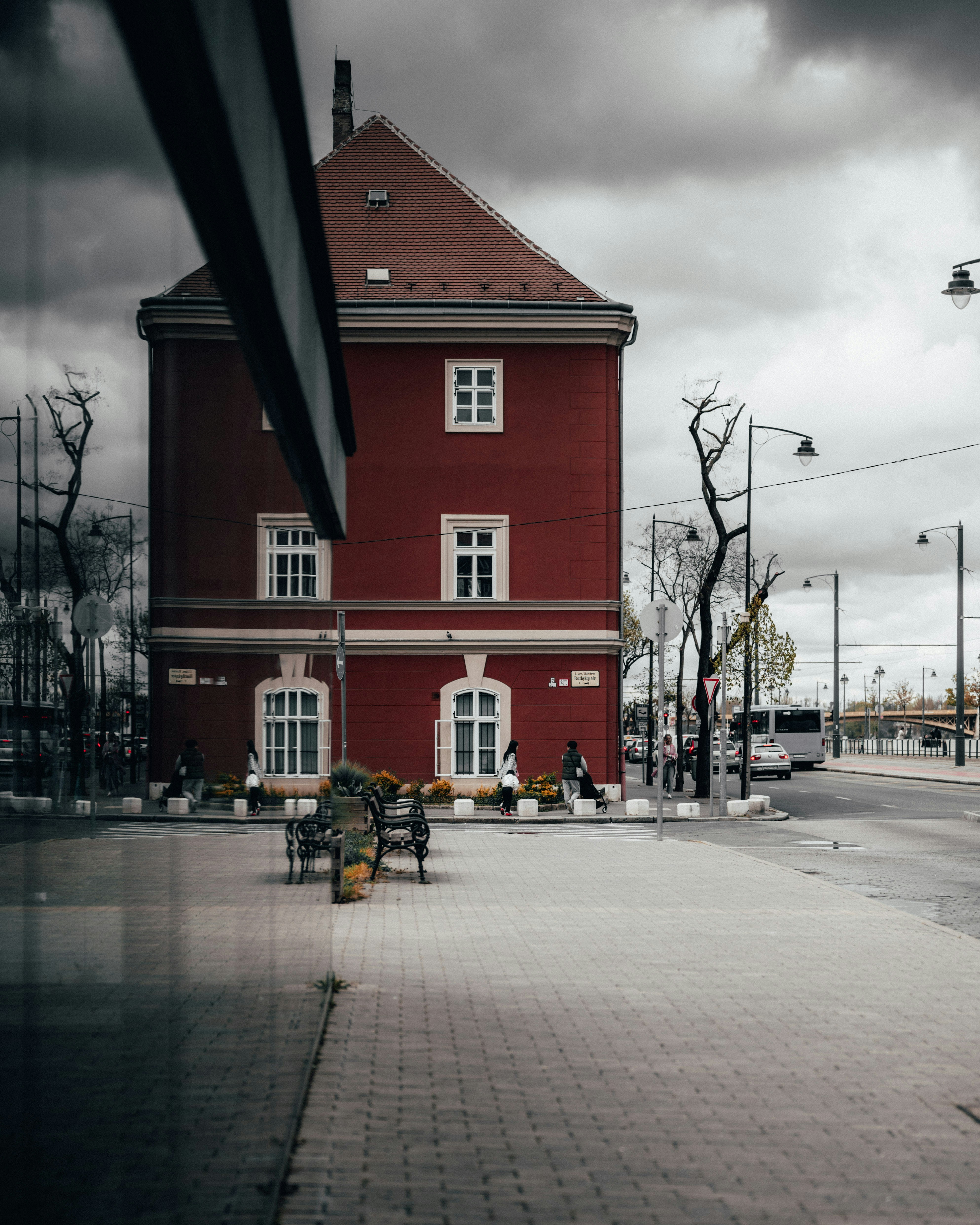 Scarlet Townhouse Against a Stormy Skyline