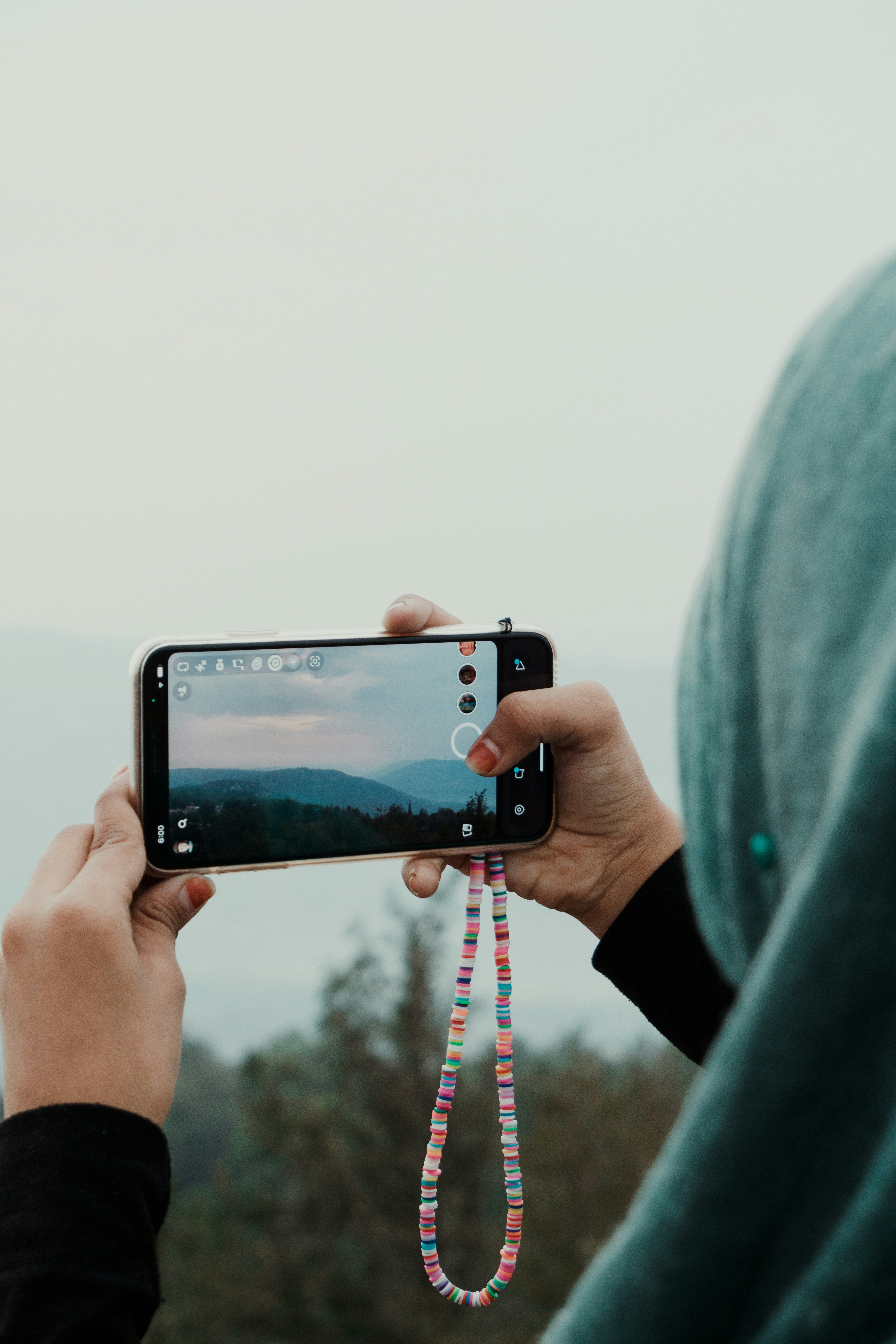 Beaded Frame on the Ridge: Handheld View of a Misty Horizon