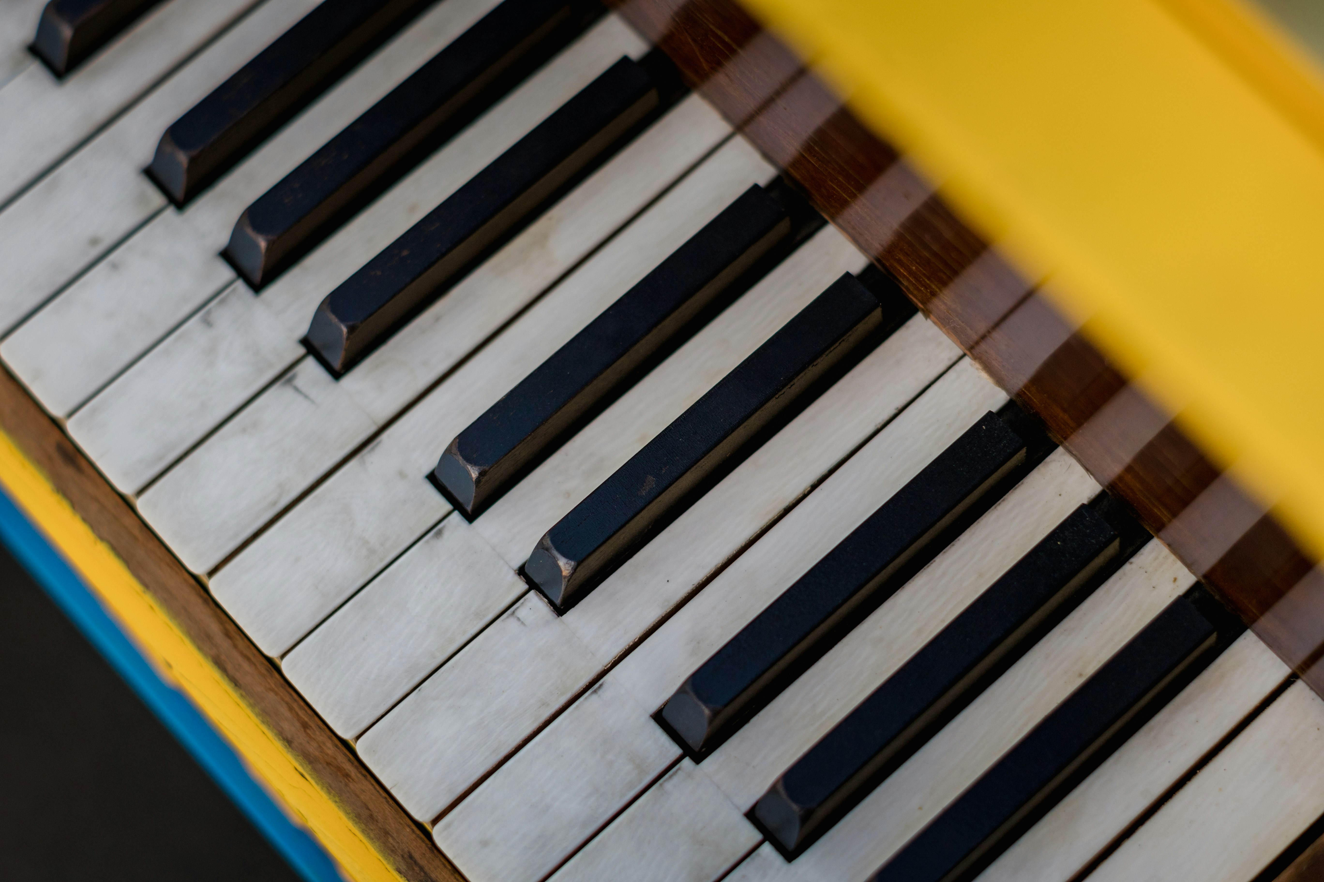 Yellow Edge, Dark Keys: Close-Up of Piano Texture