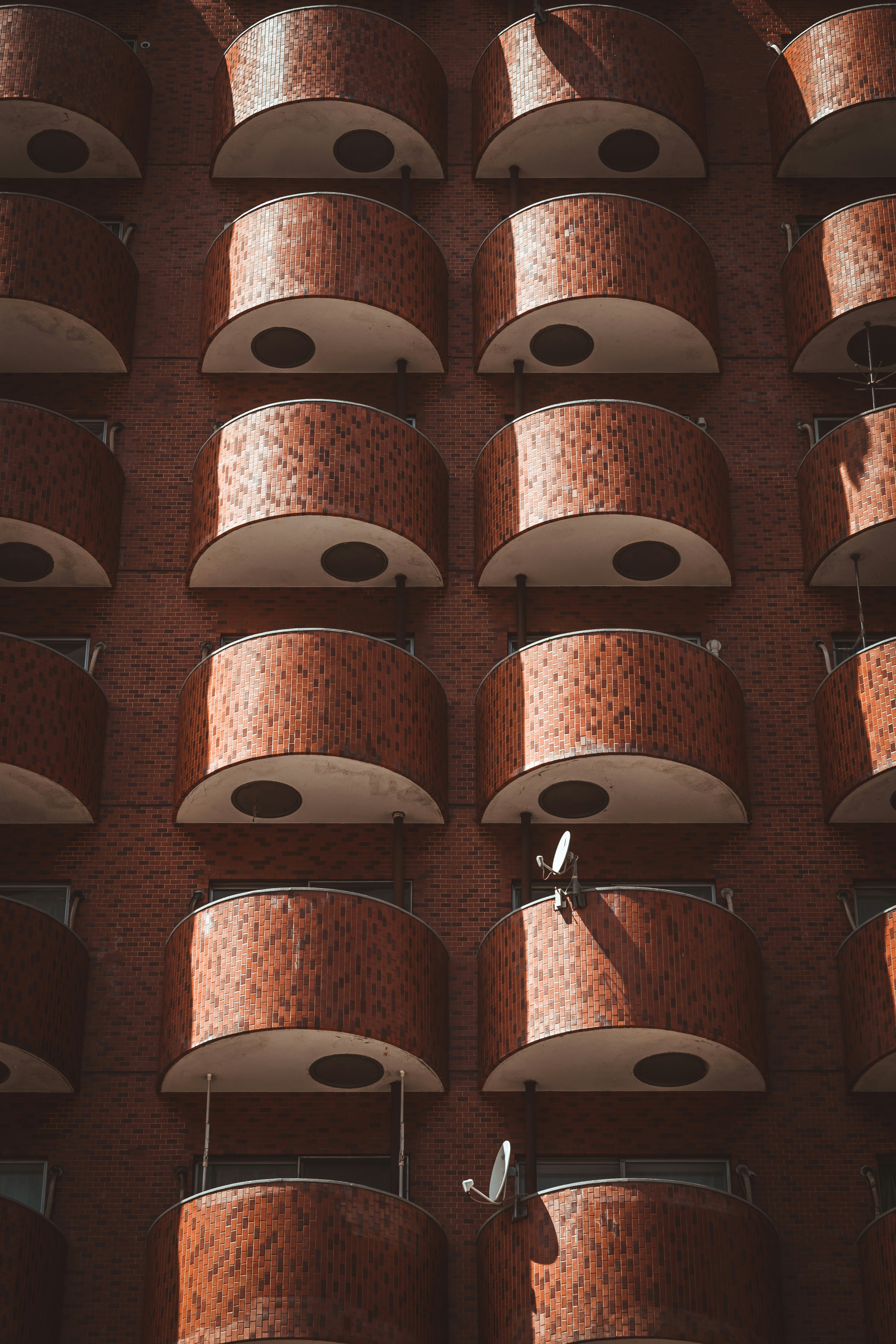Red Archipelago: A Quiet Grid of Circular Balconies