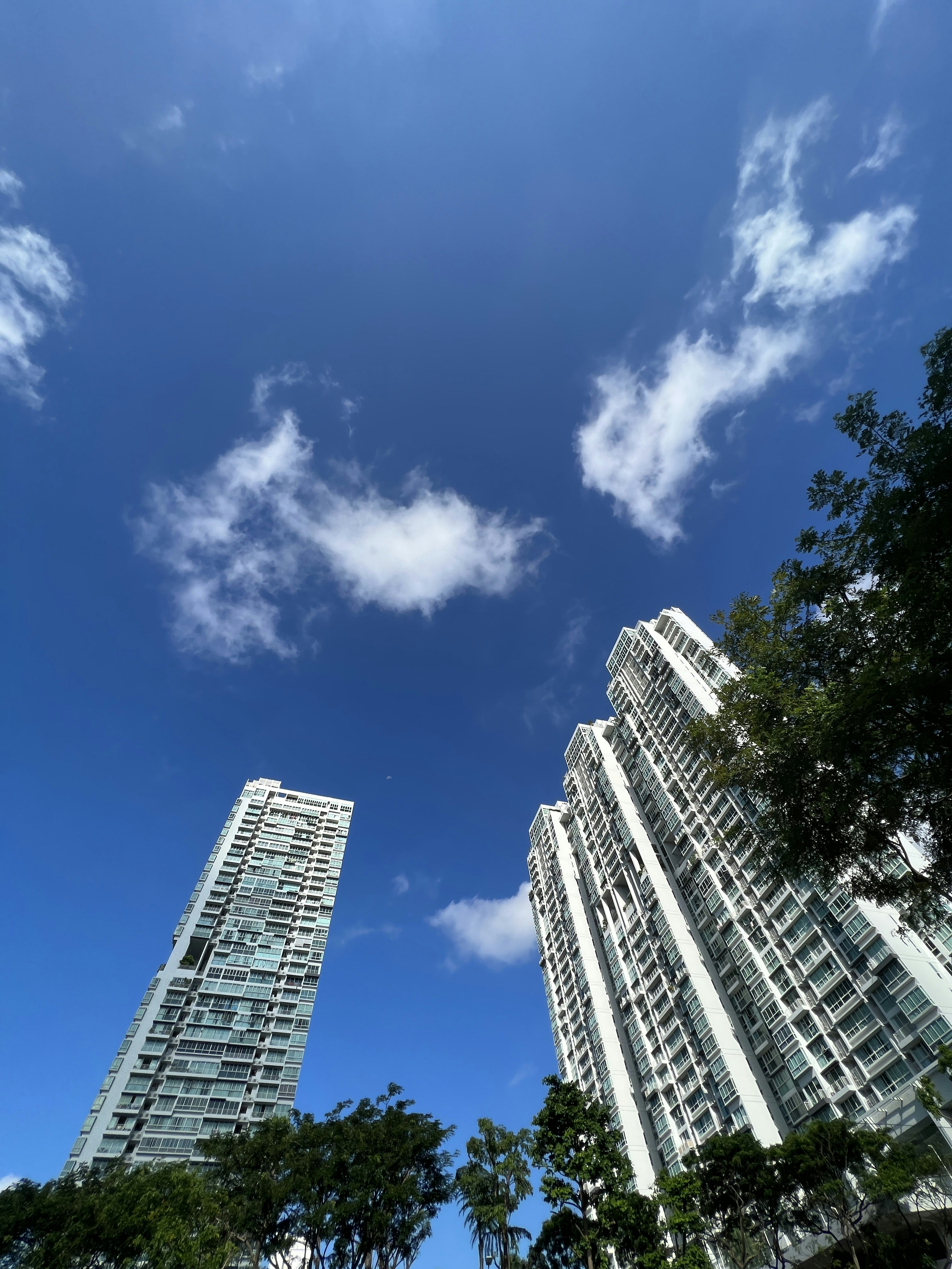 A couple of tall buildings sitting next to each other photo – Free ...